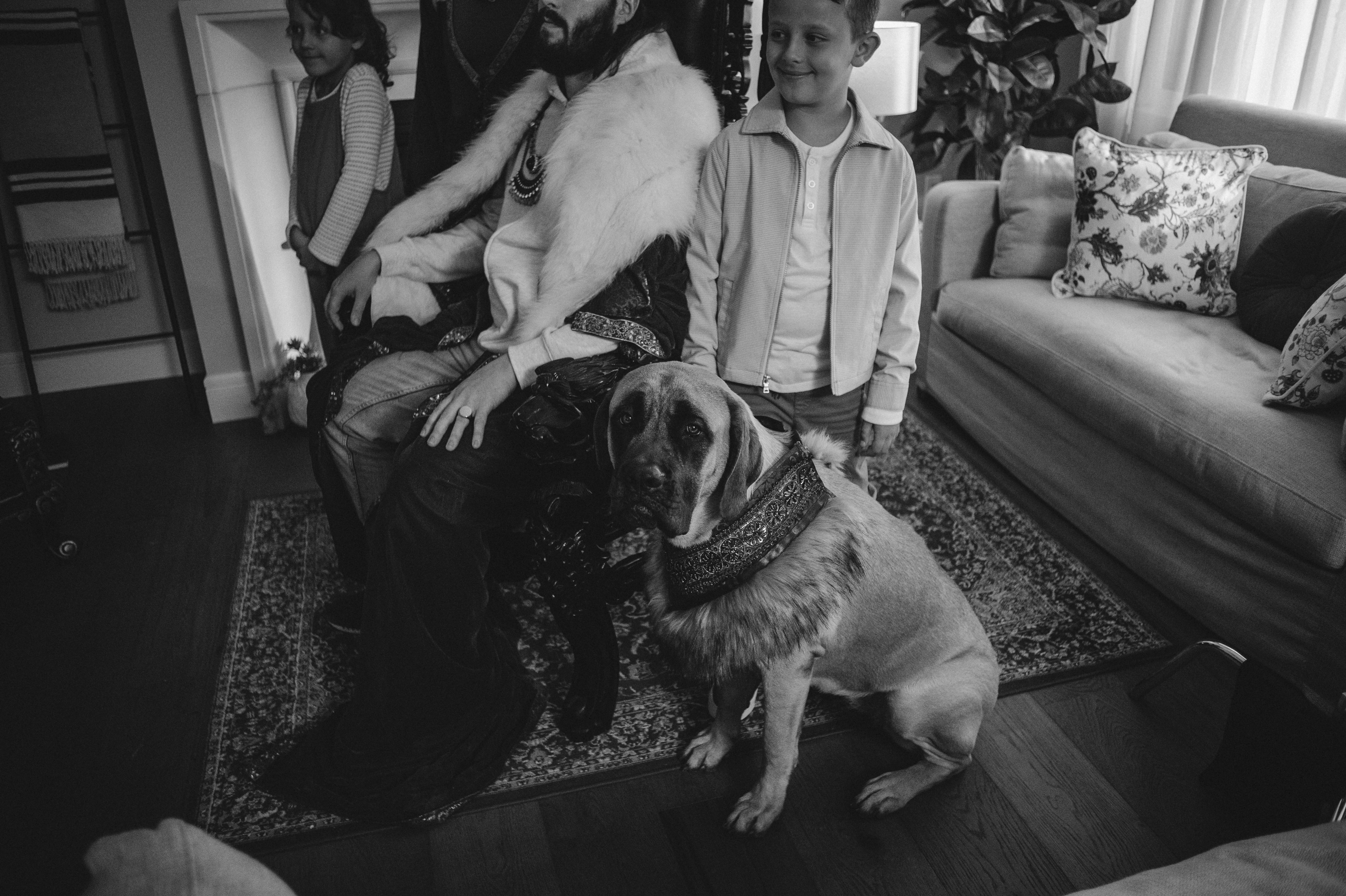 Family and dog gather in a living room