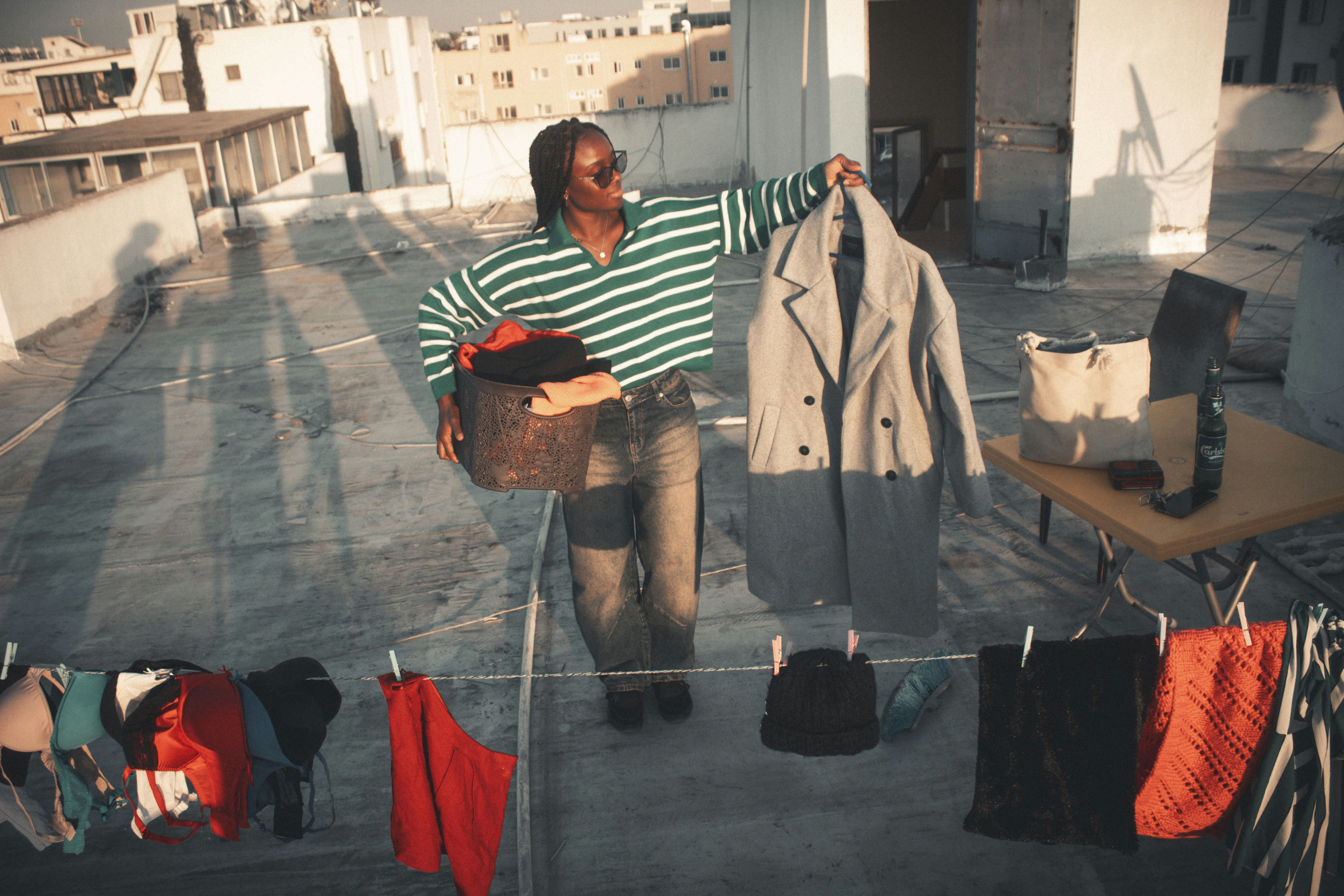 Man hanging laundry on a rooftop