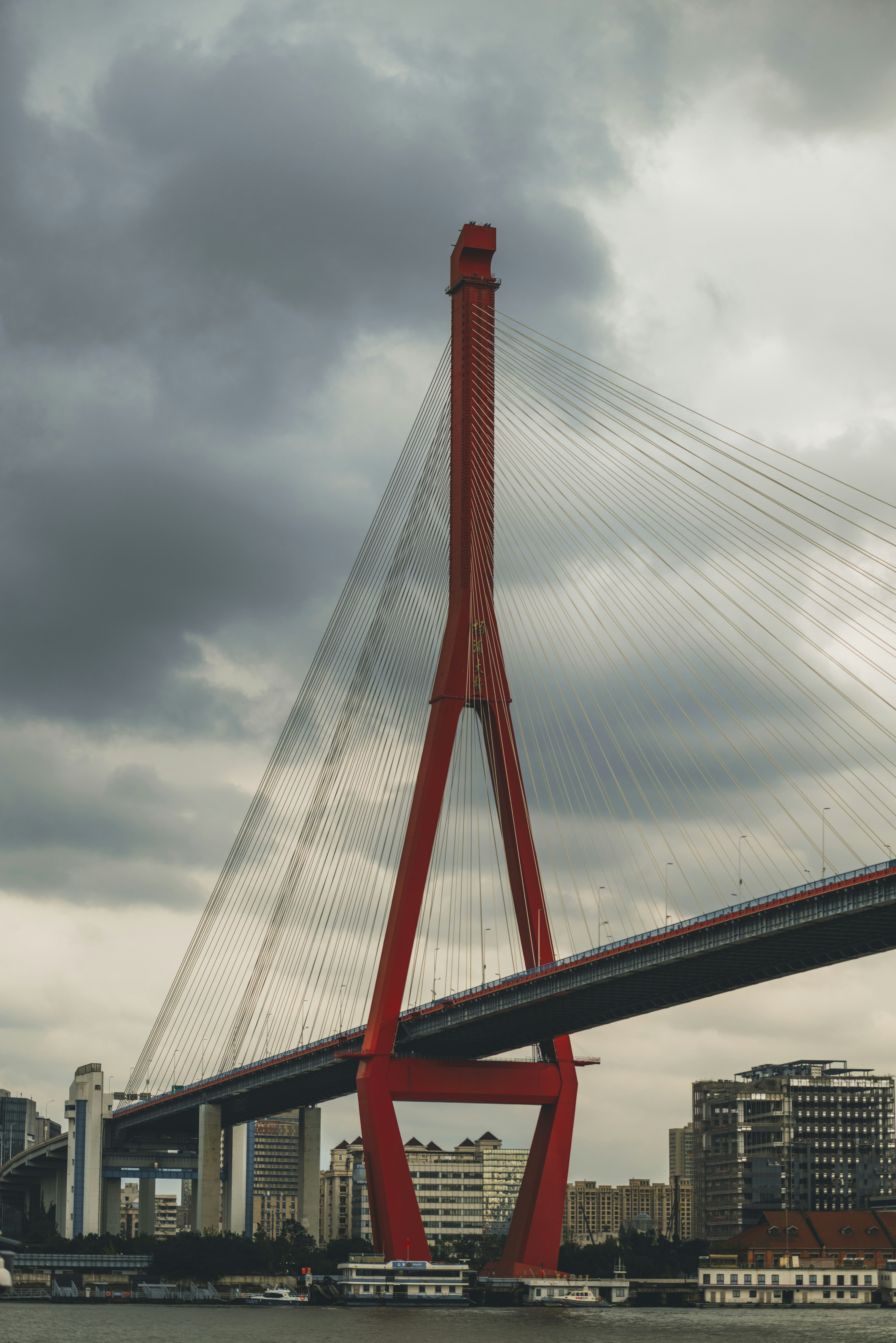The Red Symphony: A Modern Marvel Against a Gloomy Sky