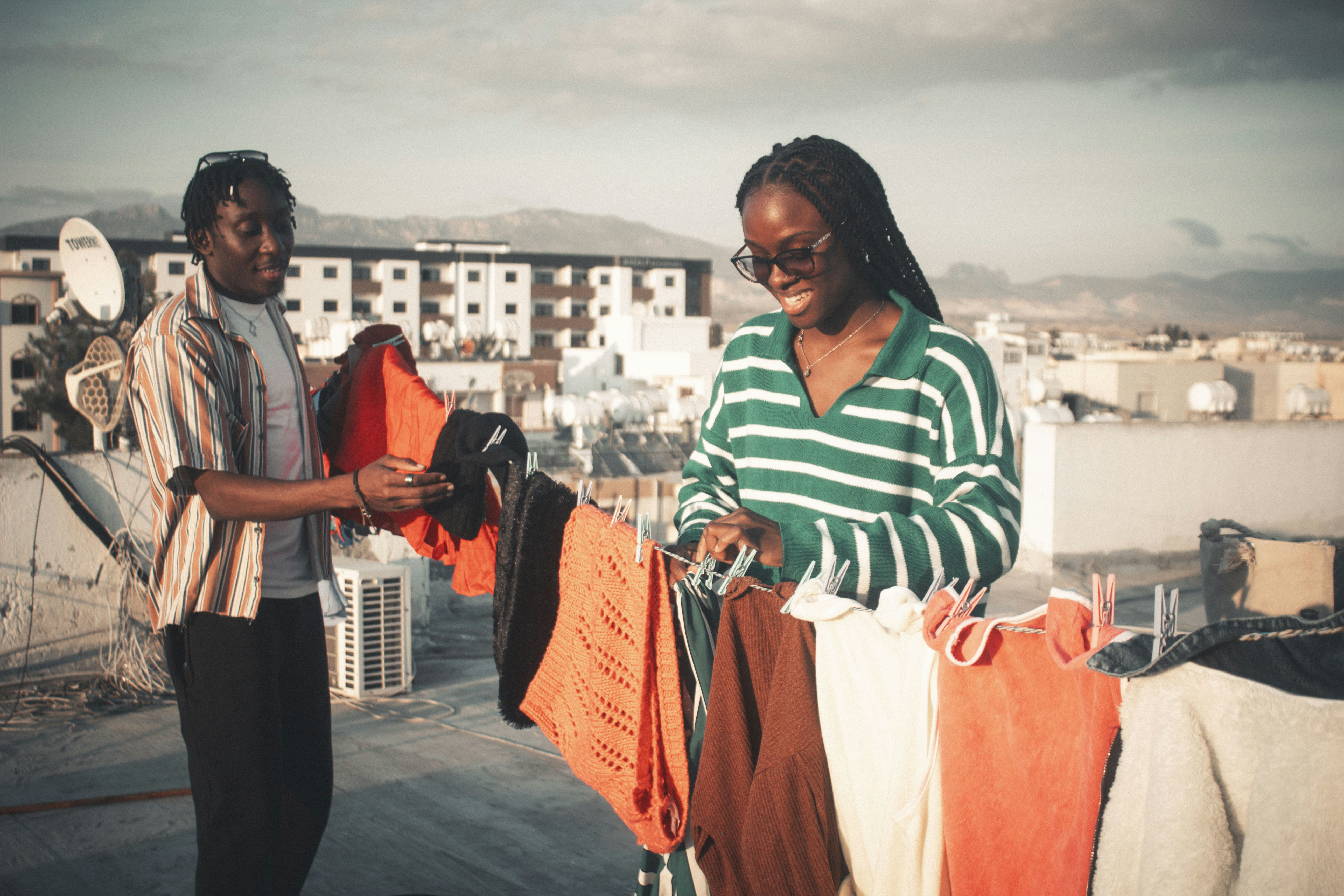 Bright Strands on the Rooftop: A Moment of Shared Laundry and Laughter