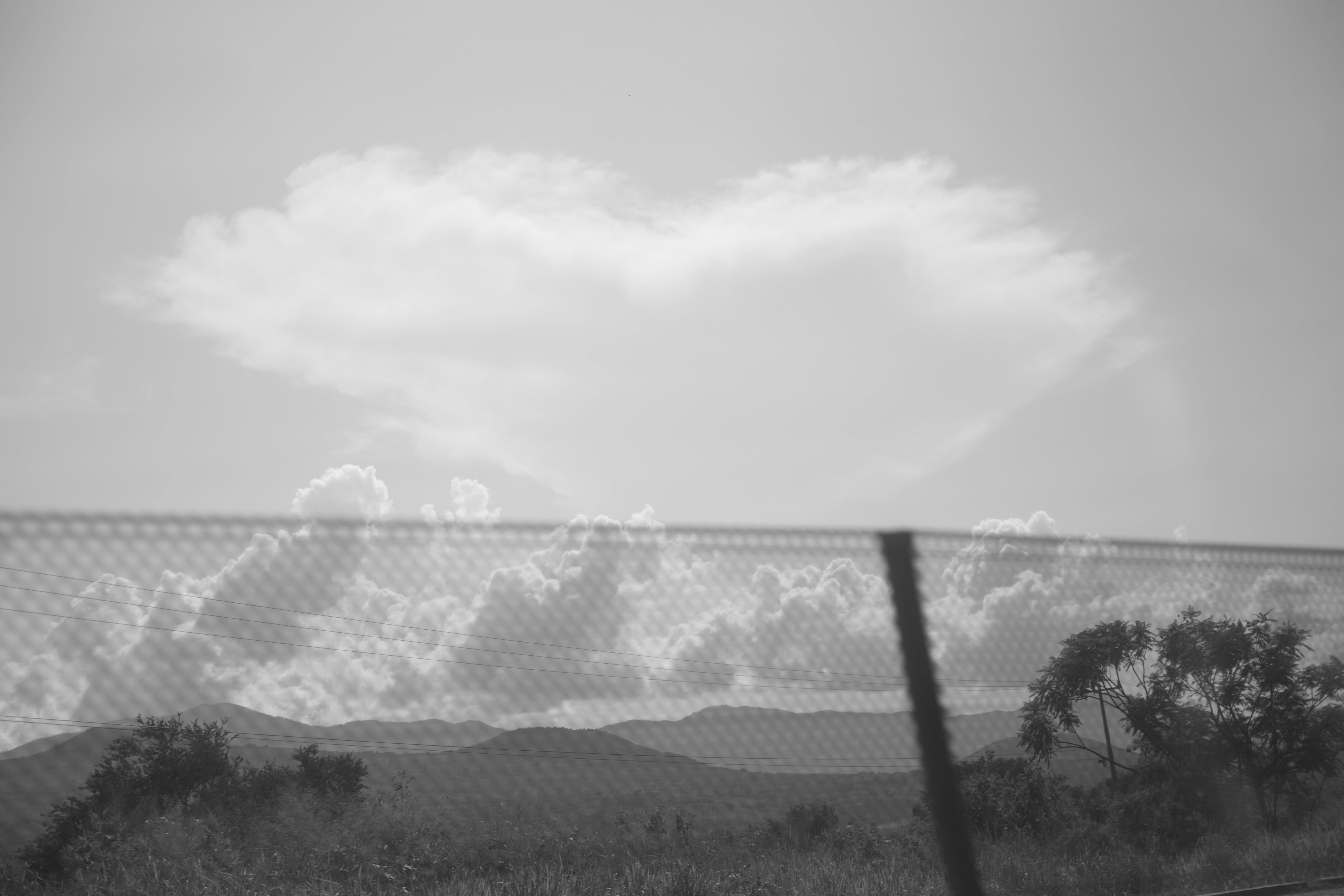 Veil of Clouds Over Distant Peaks