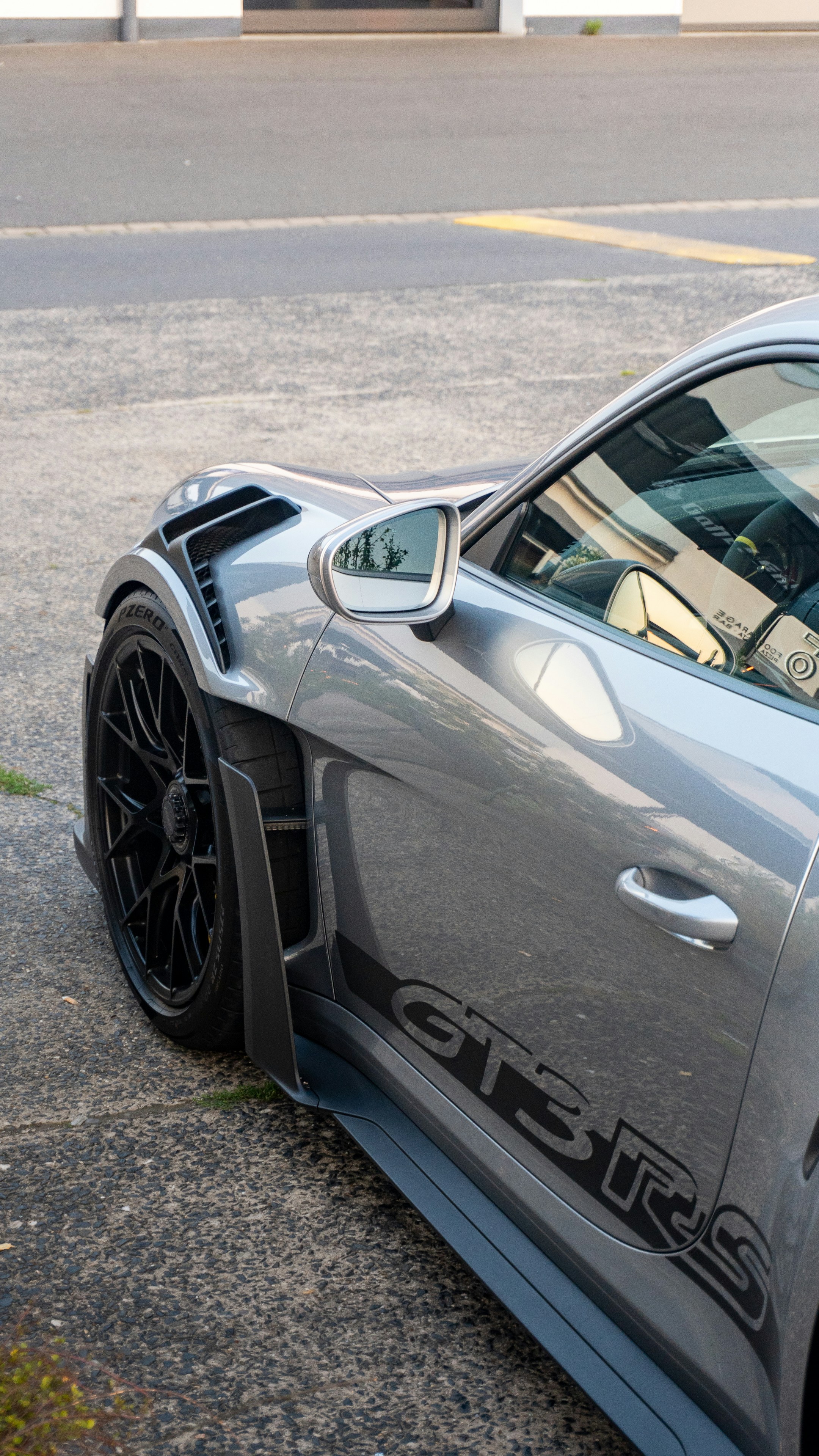 Silver porsche gt3 rs parked on asphalt