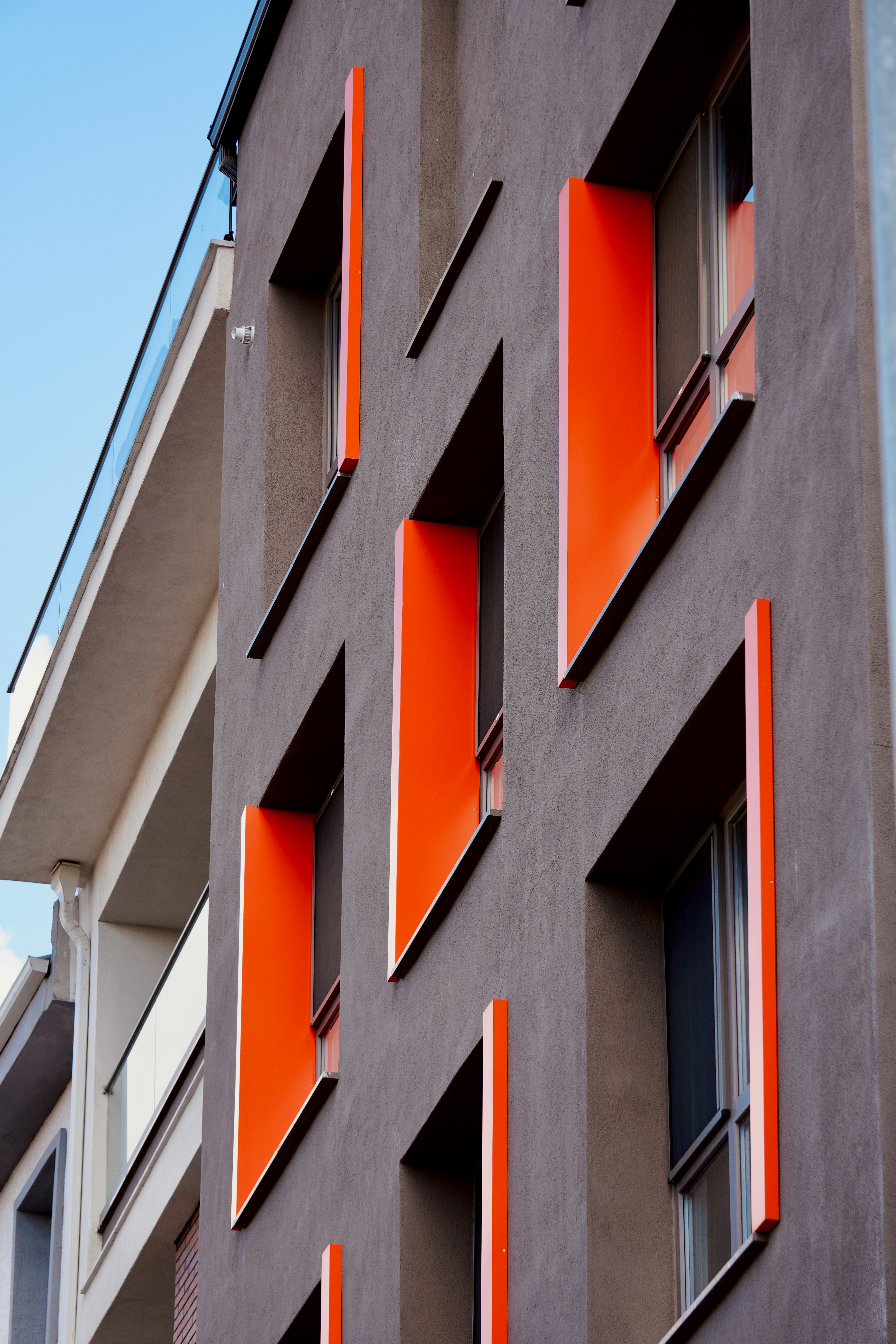 Modern building facade with orange window accents