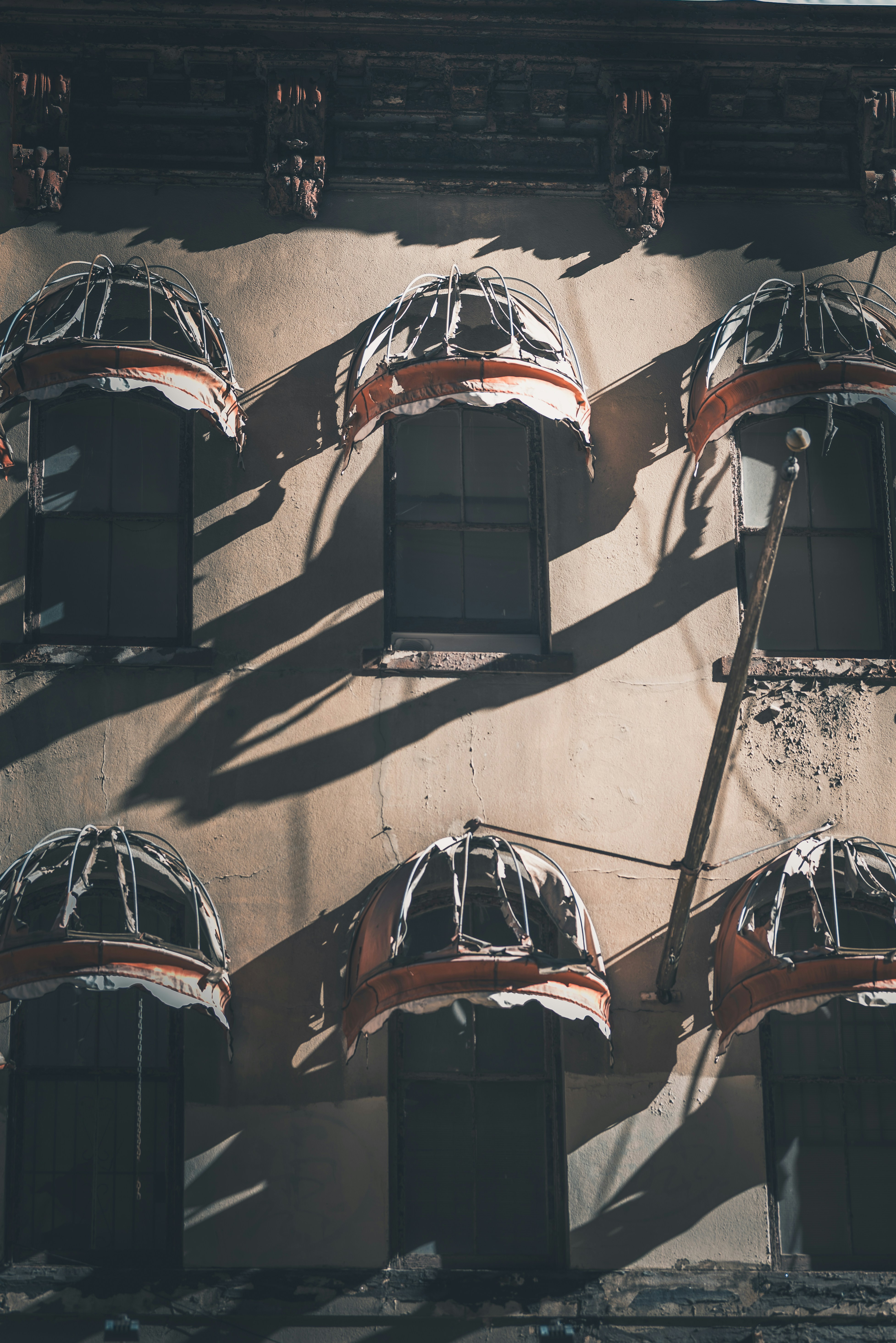 Old building facade with arched windows and awnings