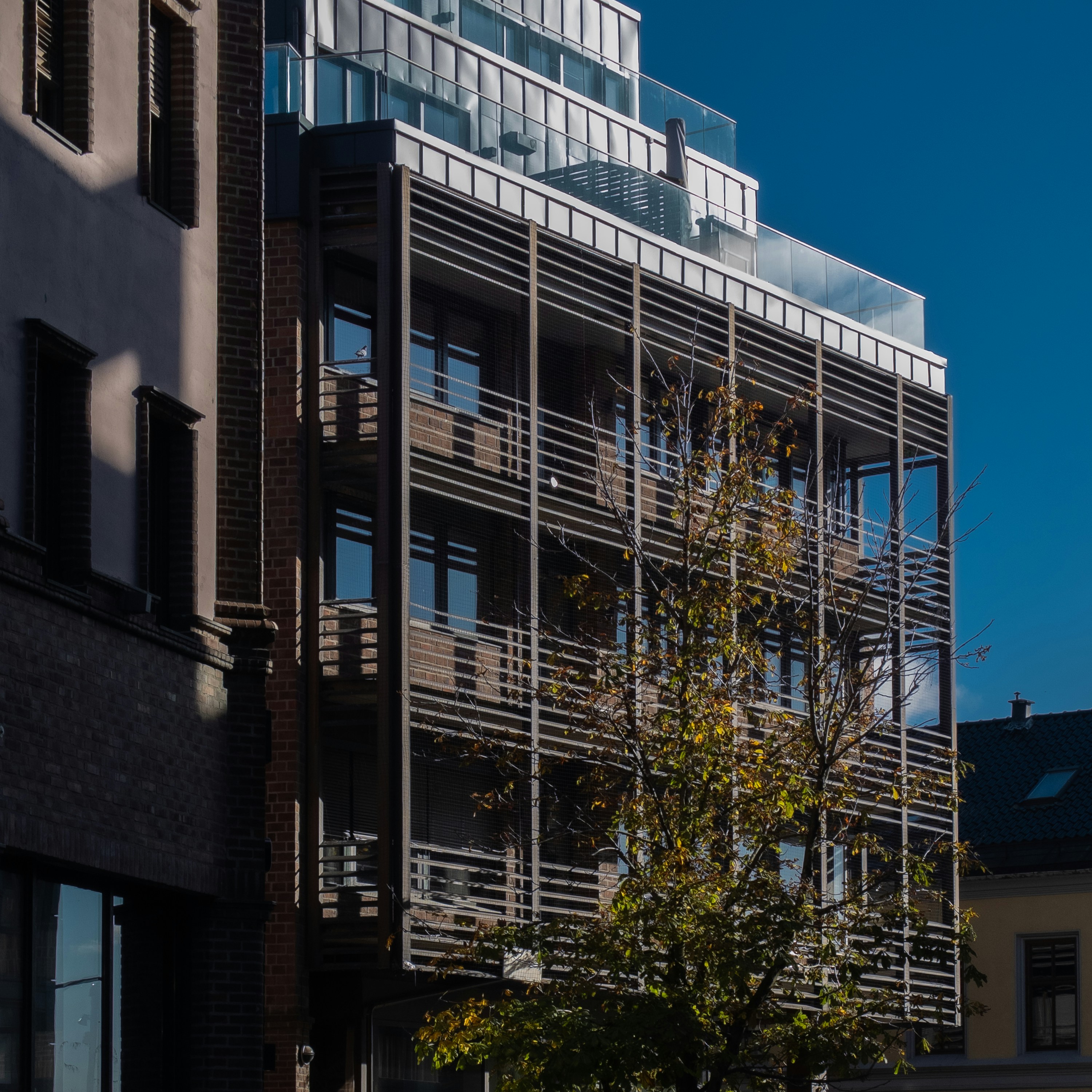 Modern building with wooden facade and balconies.