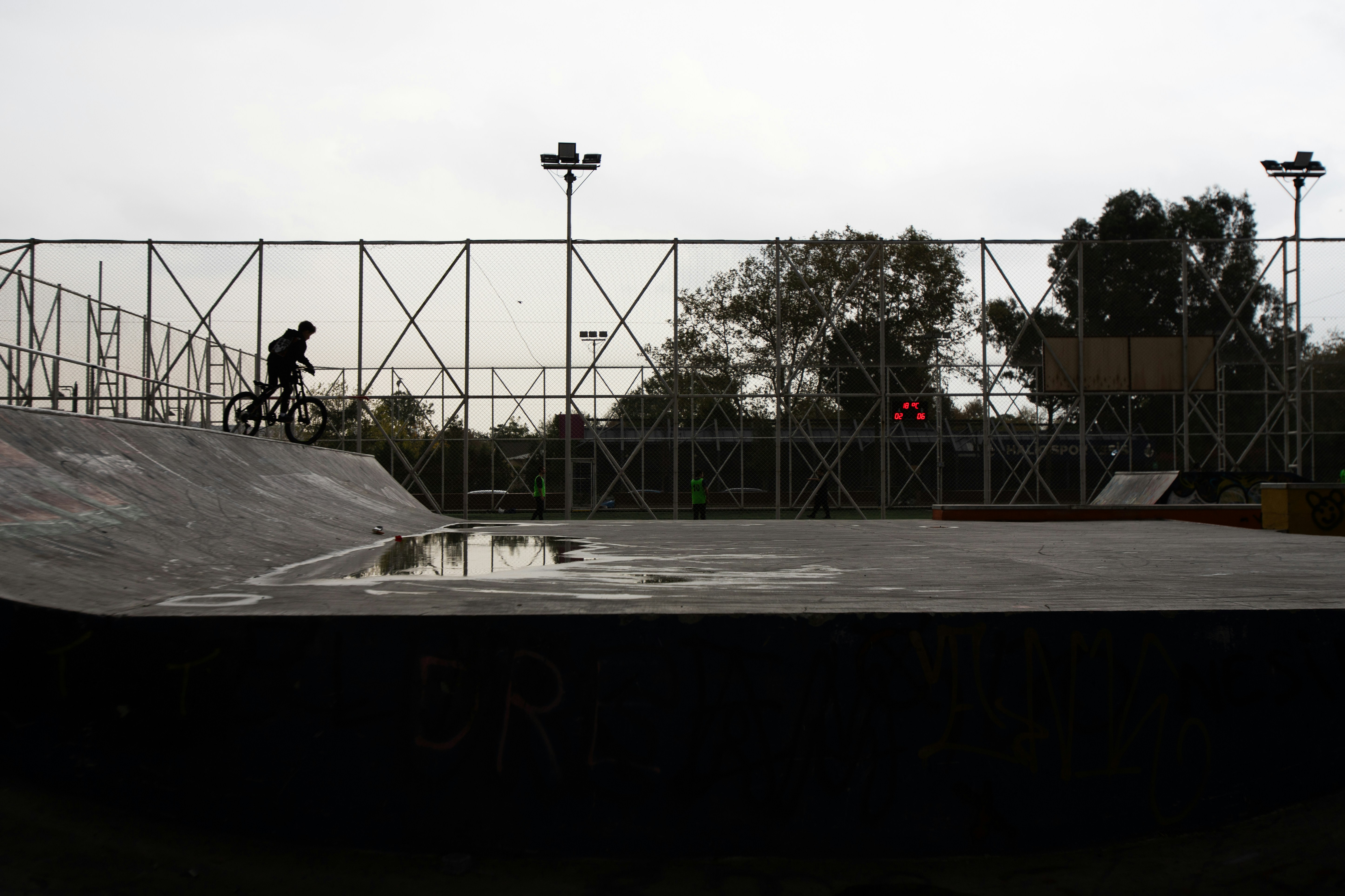 A bmx rider on a ramp at a skatepark.