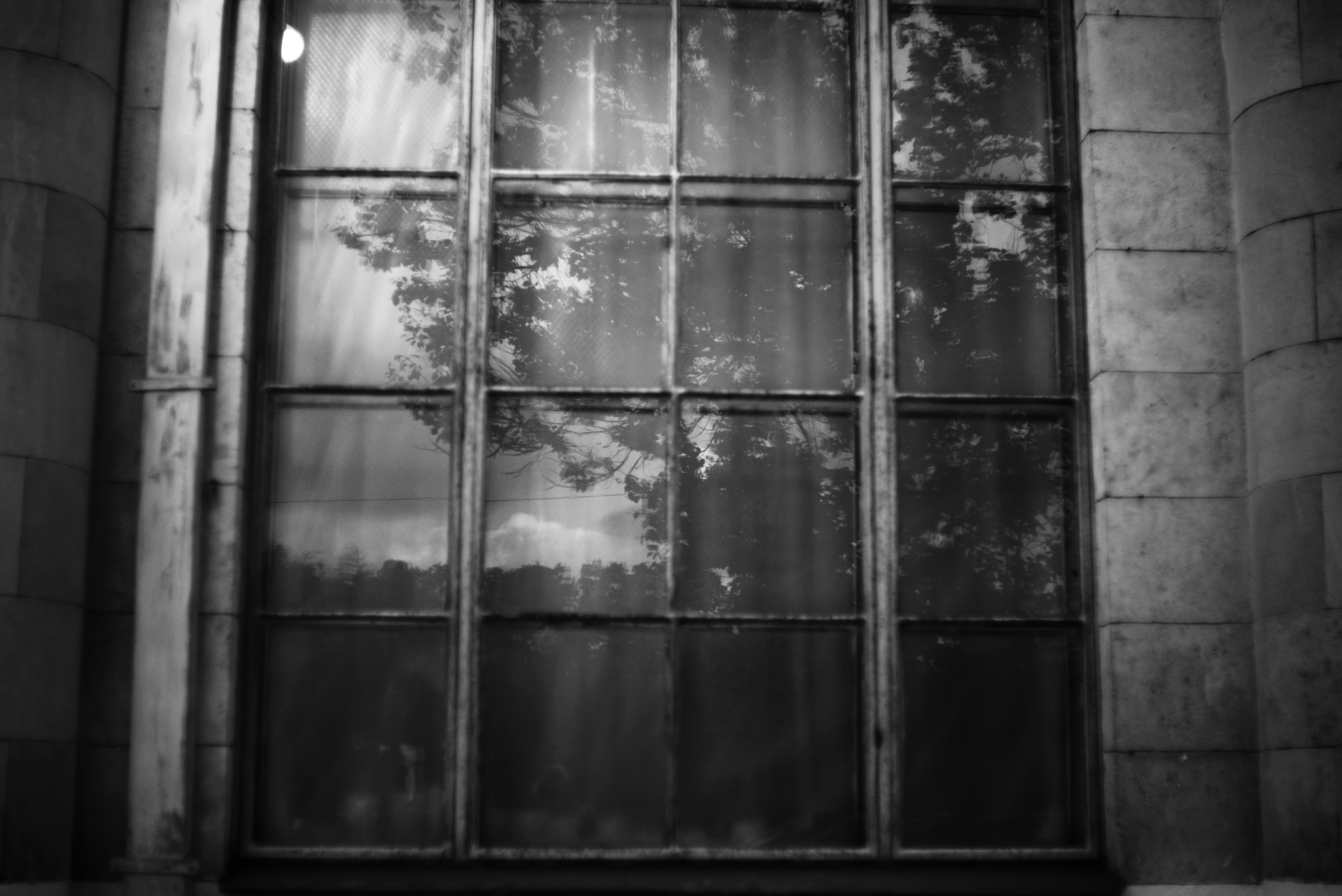 Grungy window with cloudy sky reflection