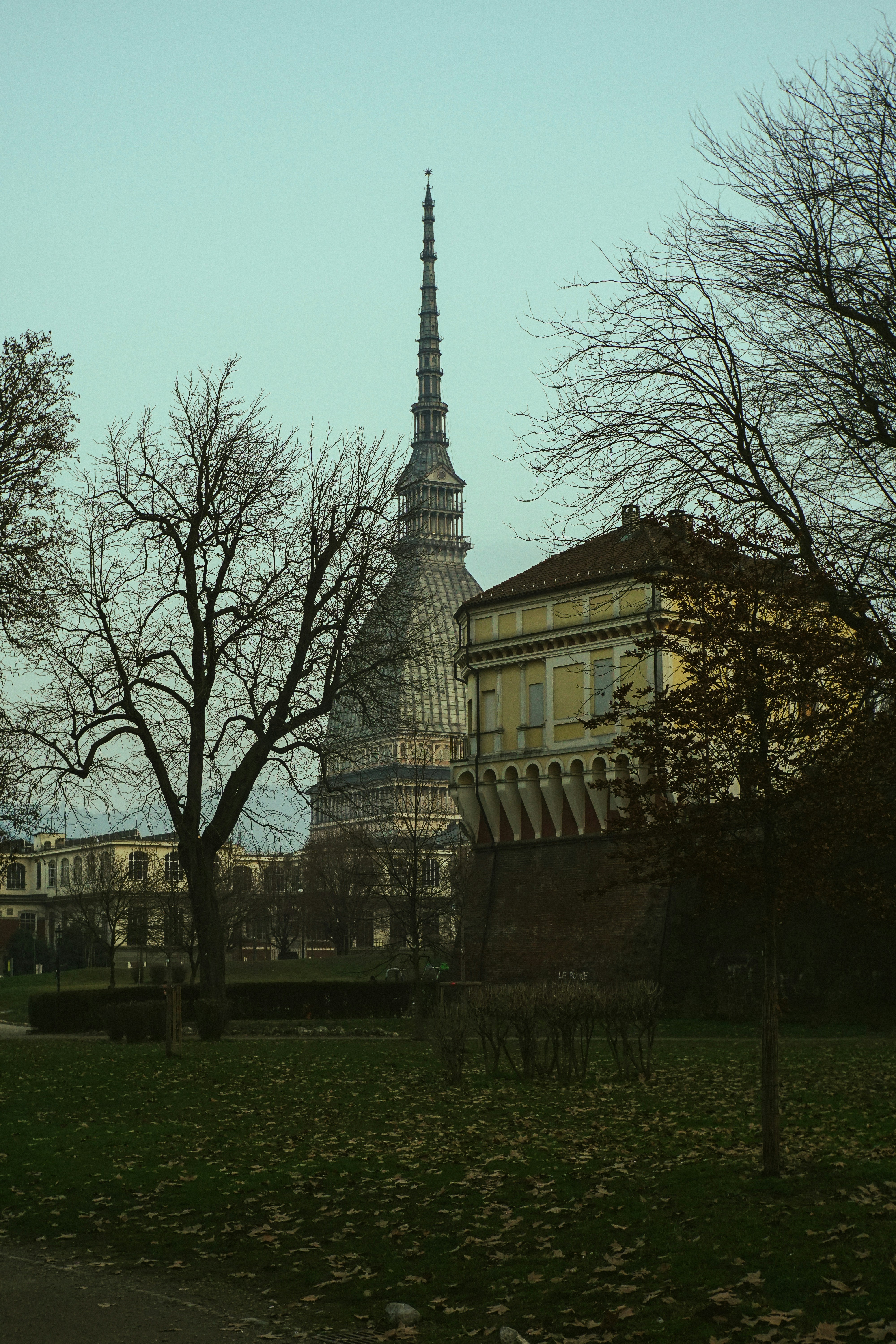 View of the Mole Antonelliana from Giardini Reali, Torino, Italy. | Mole antonelliana building with trees in foreground