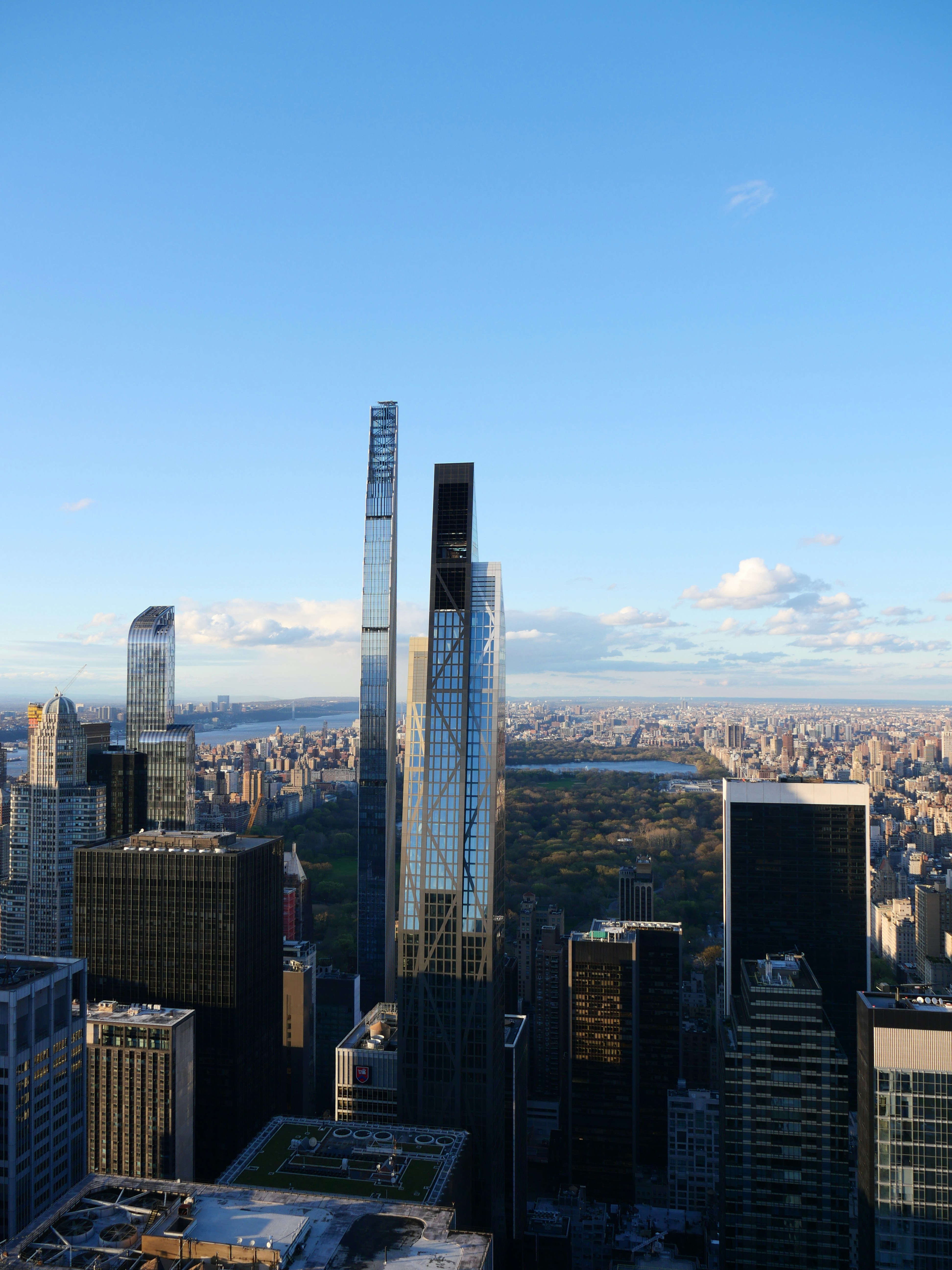 Skyscrapers overlook central park on a clear day.