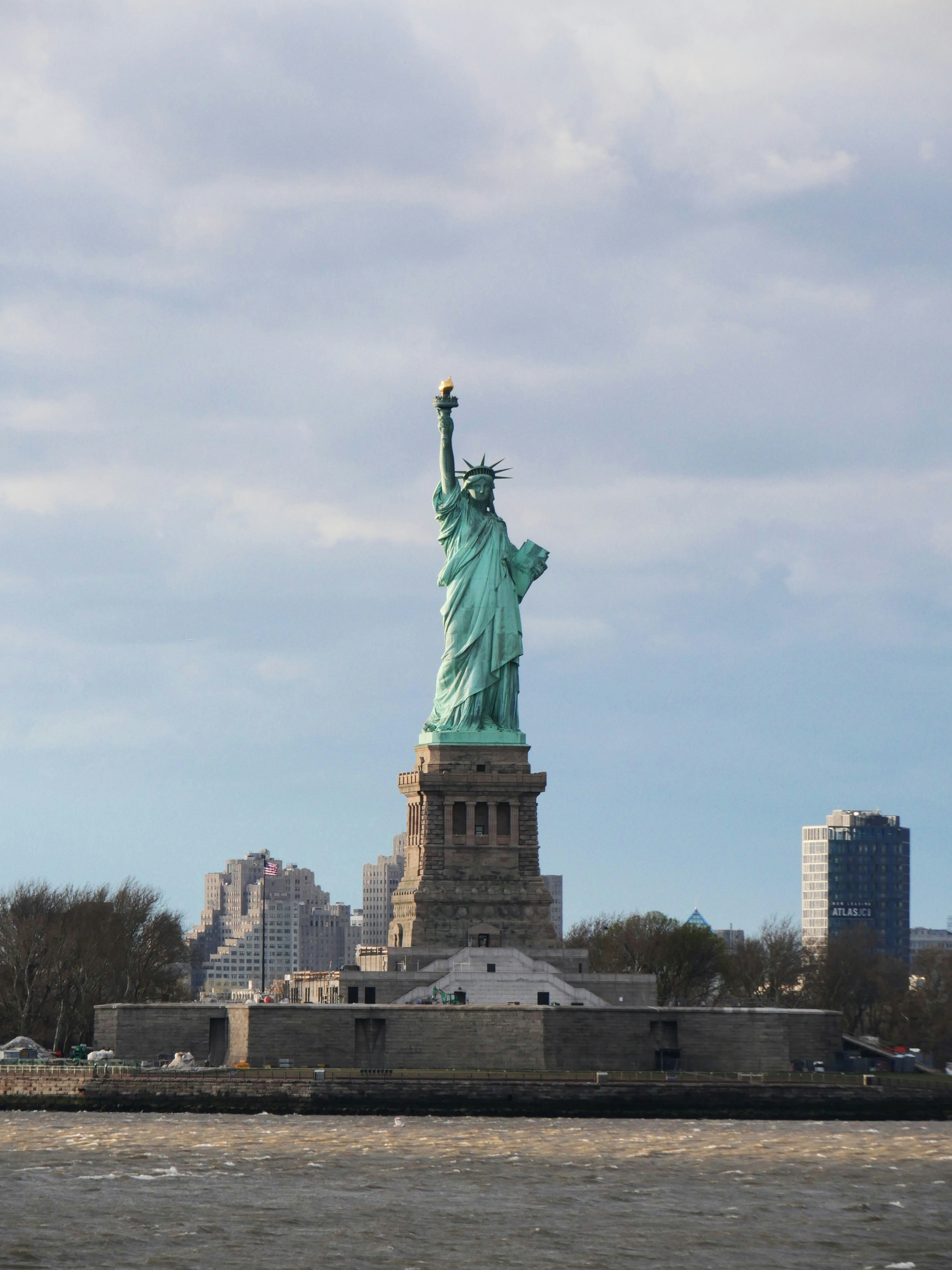 The statue of liberty stands tall against the sky.