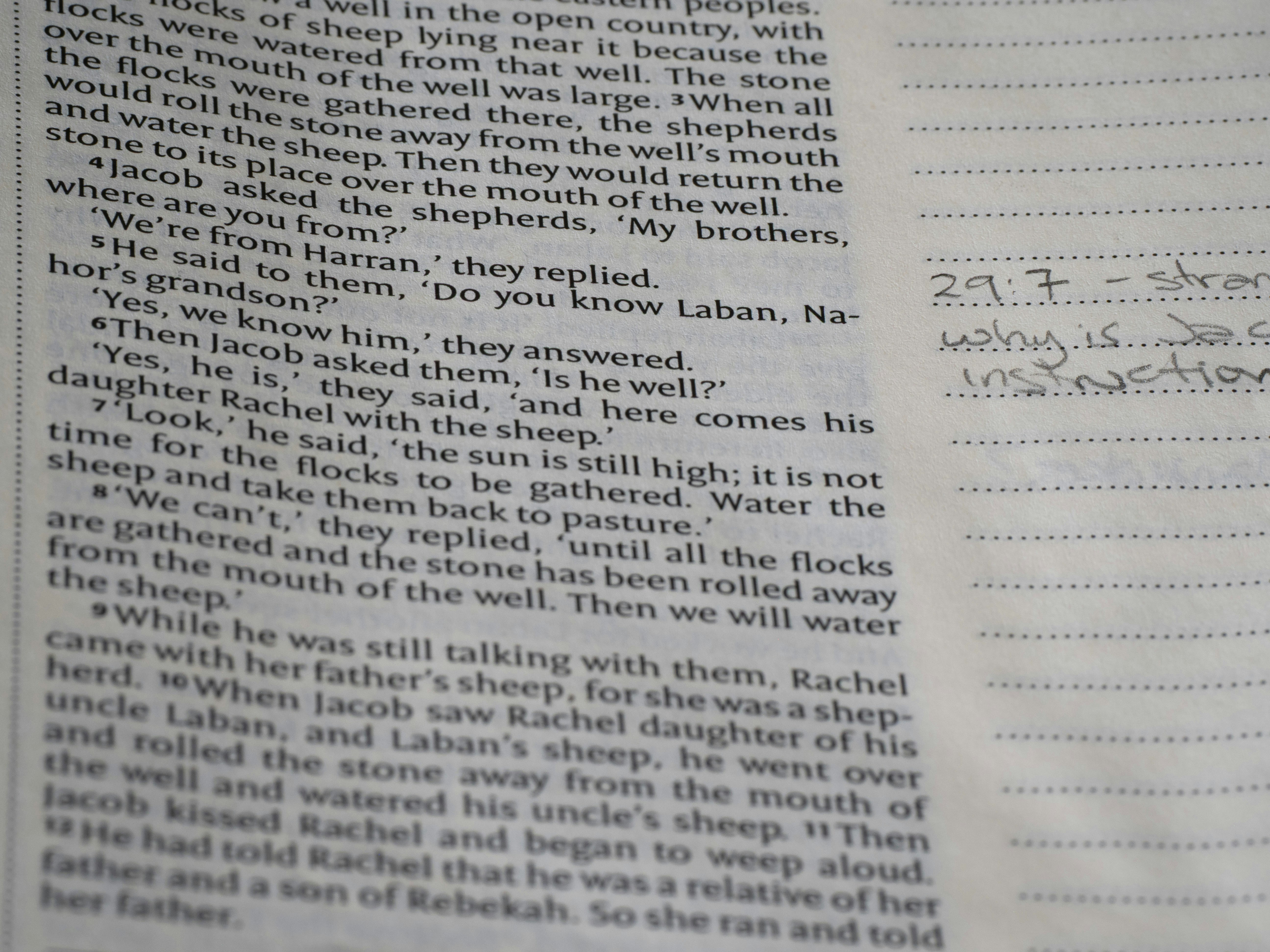 The Book of Genesis | Close-up of open book pages with text.