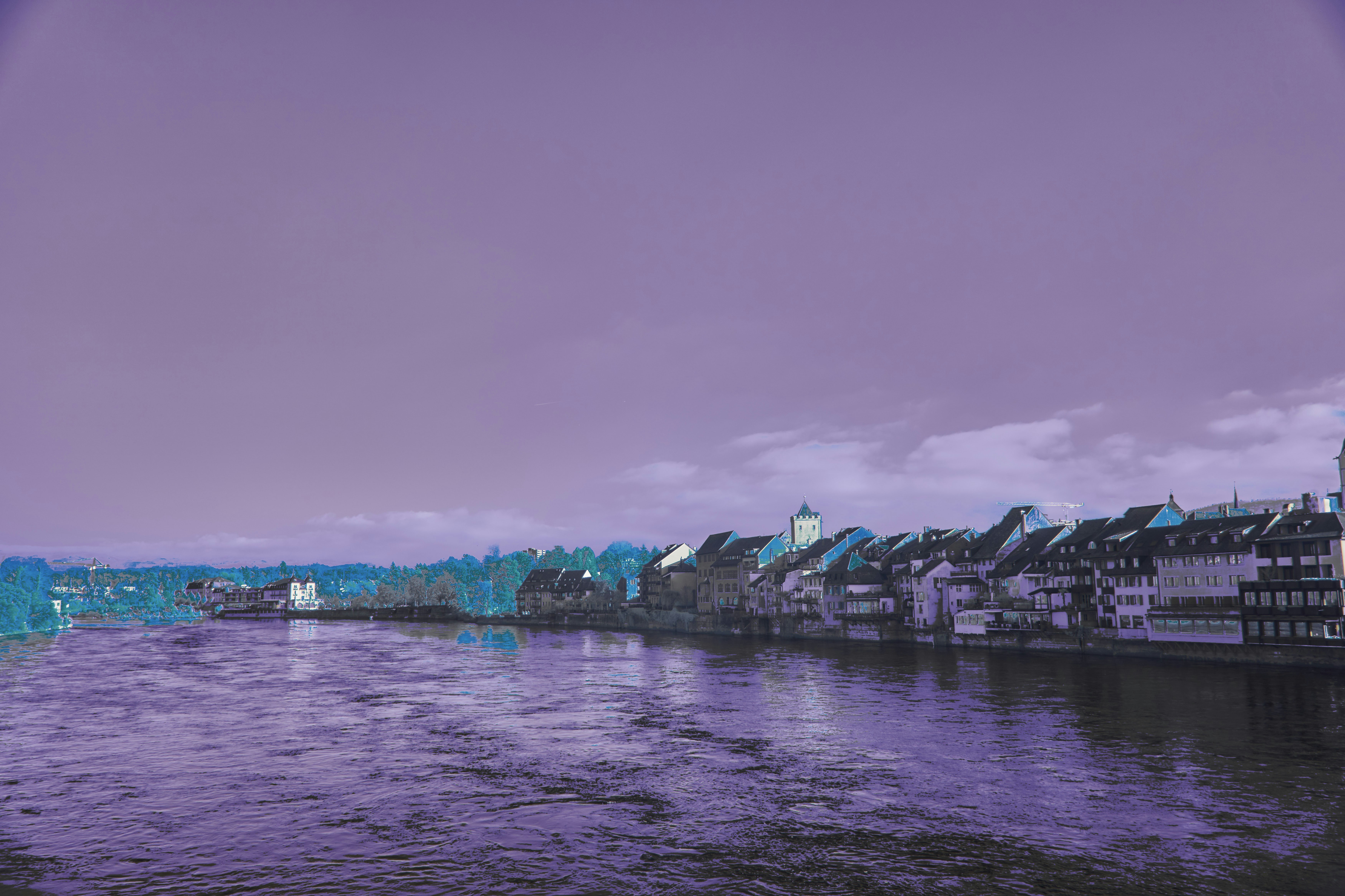 City skyline reflected in a purple river