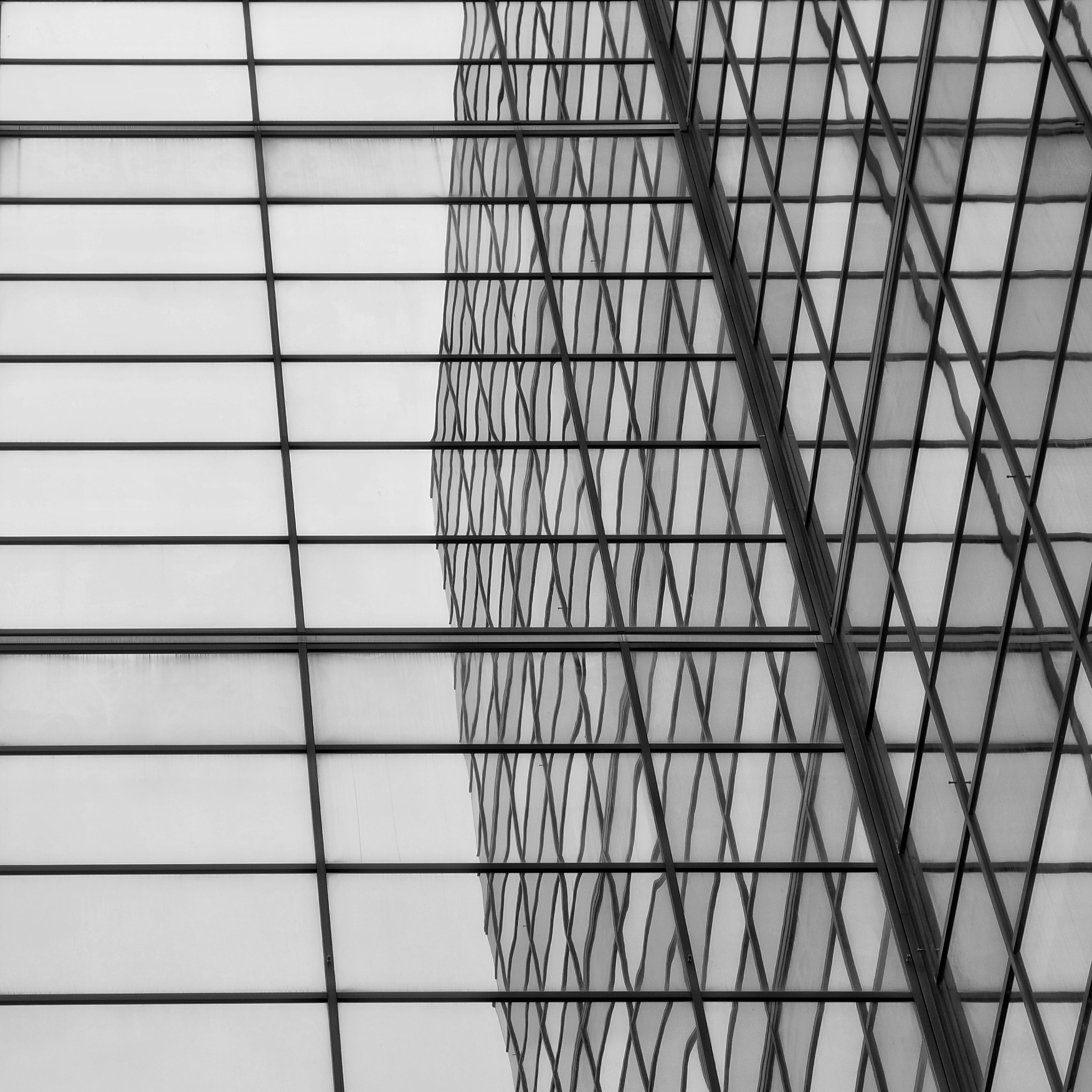 City Architecture | Modern glass building facade with geometric patterns.