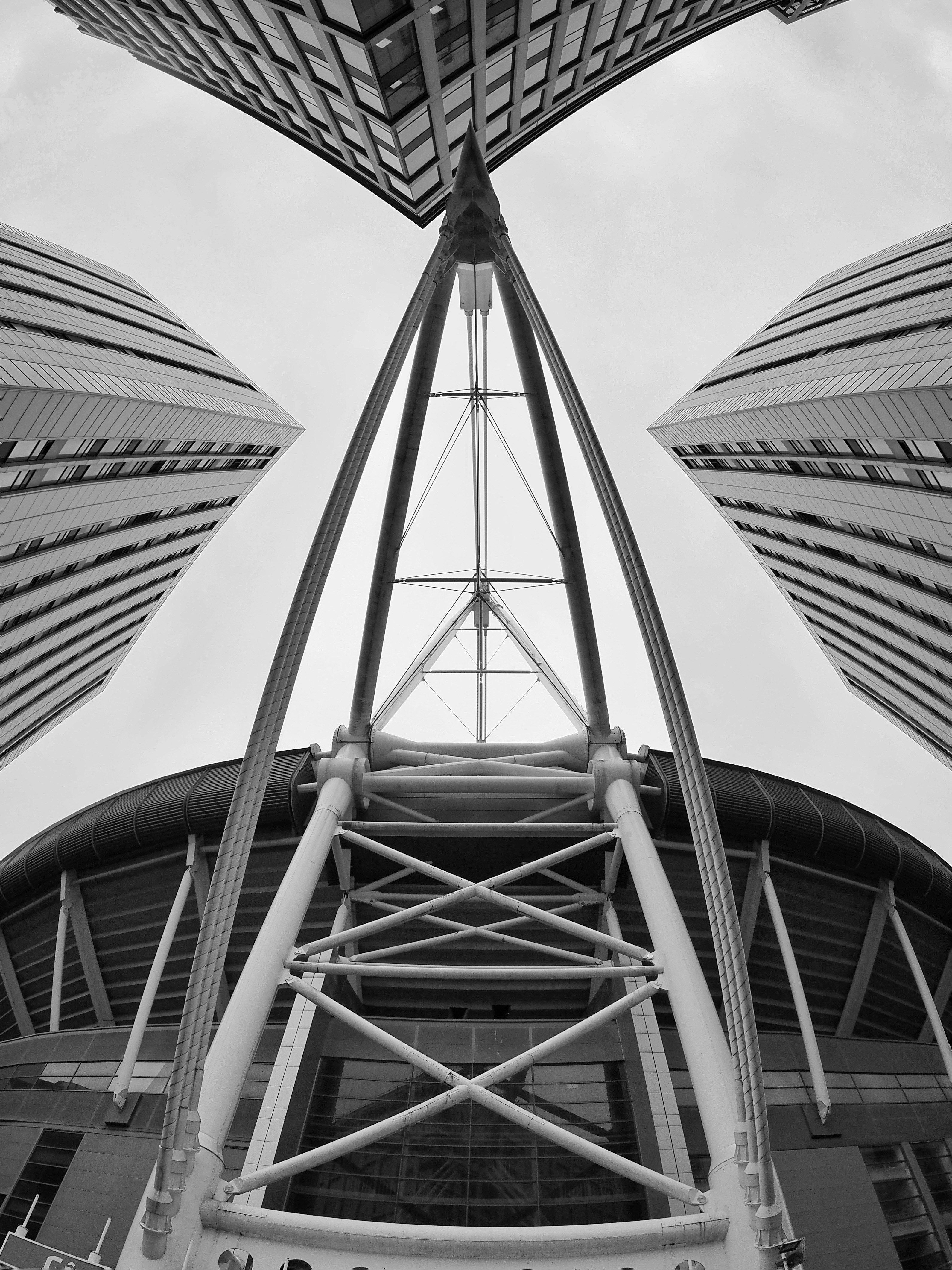 City Architecture | Symmetrical view of modern buildings and stadium structure.