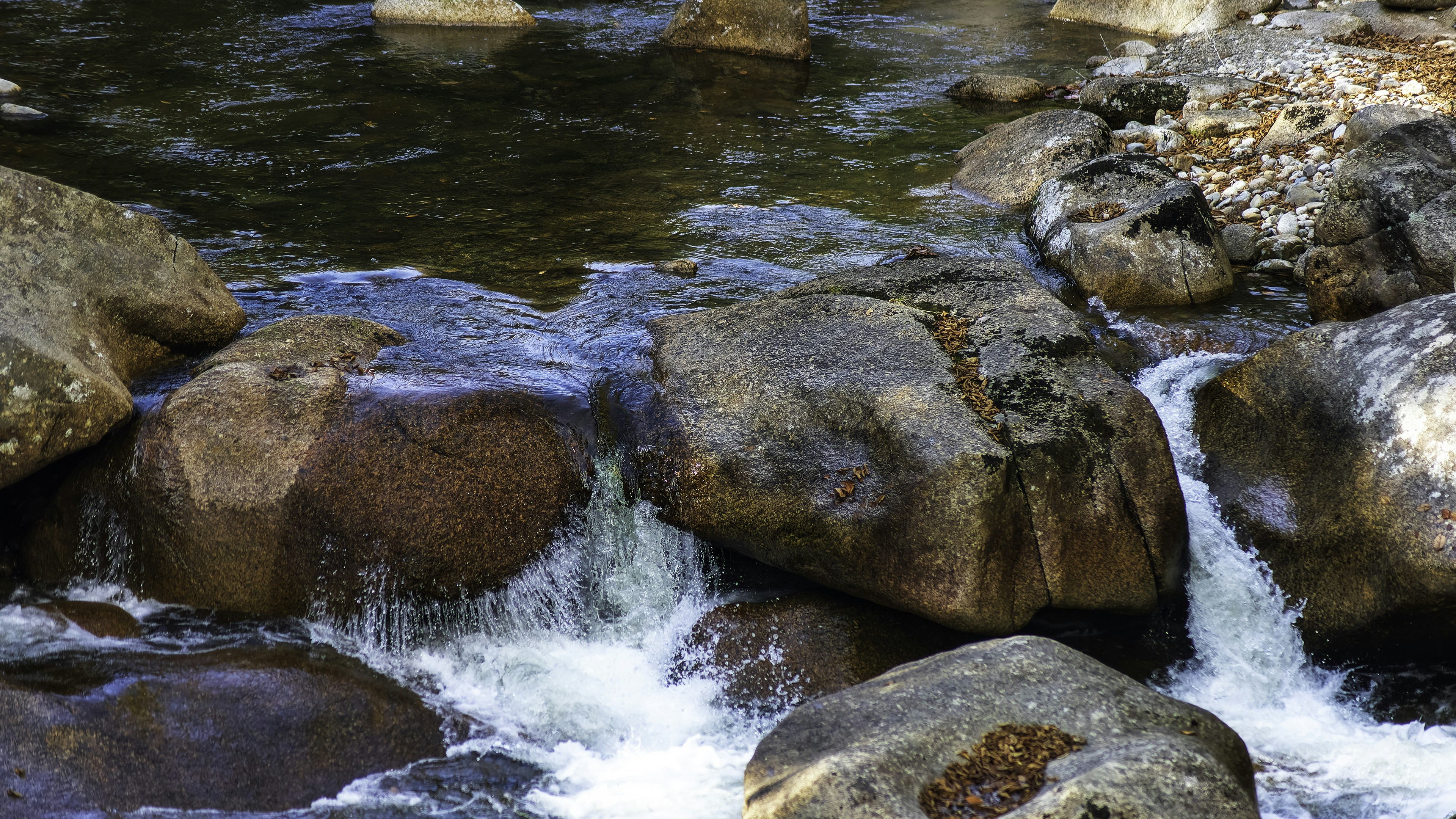 Rock Cascade — clear mountain water rushing over granite stones | Water flowing over large rocks in a stream