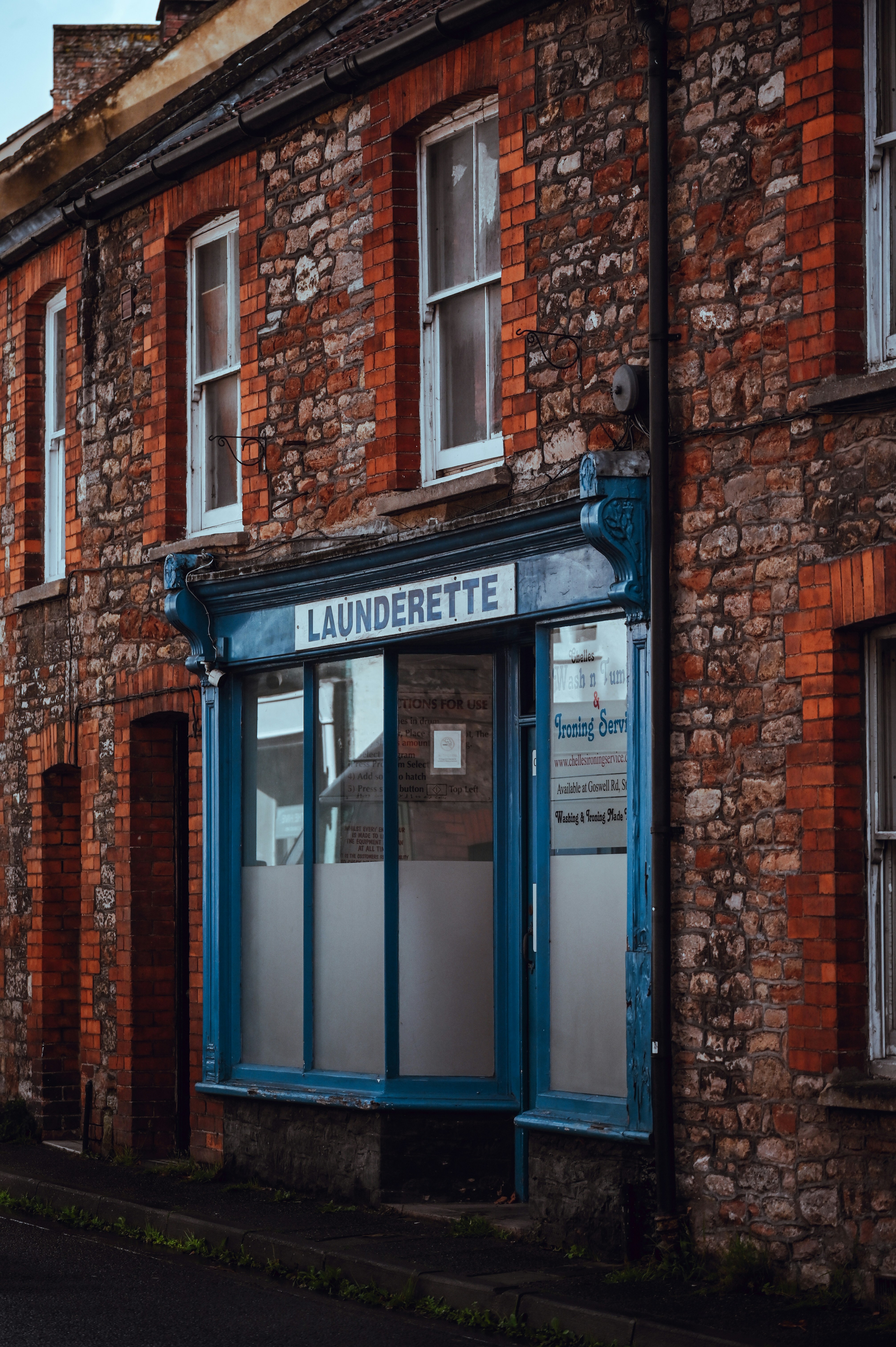 Old Launderette | A brick building with a laundrette storefront.