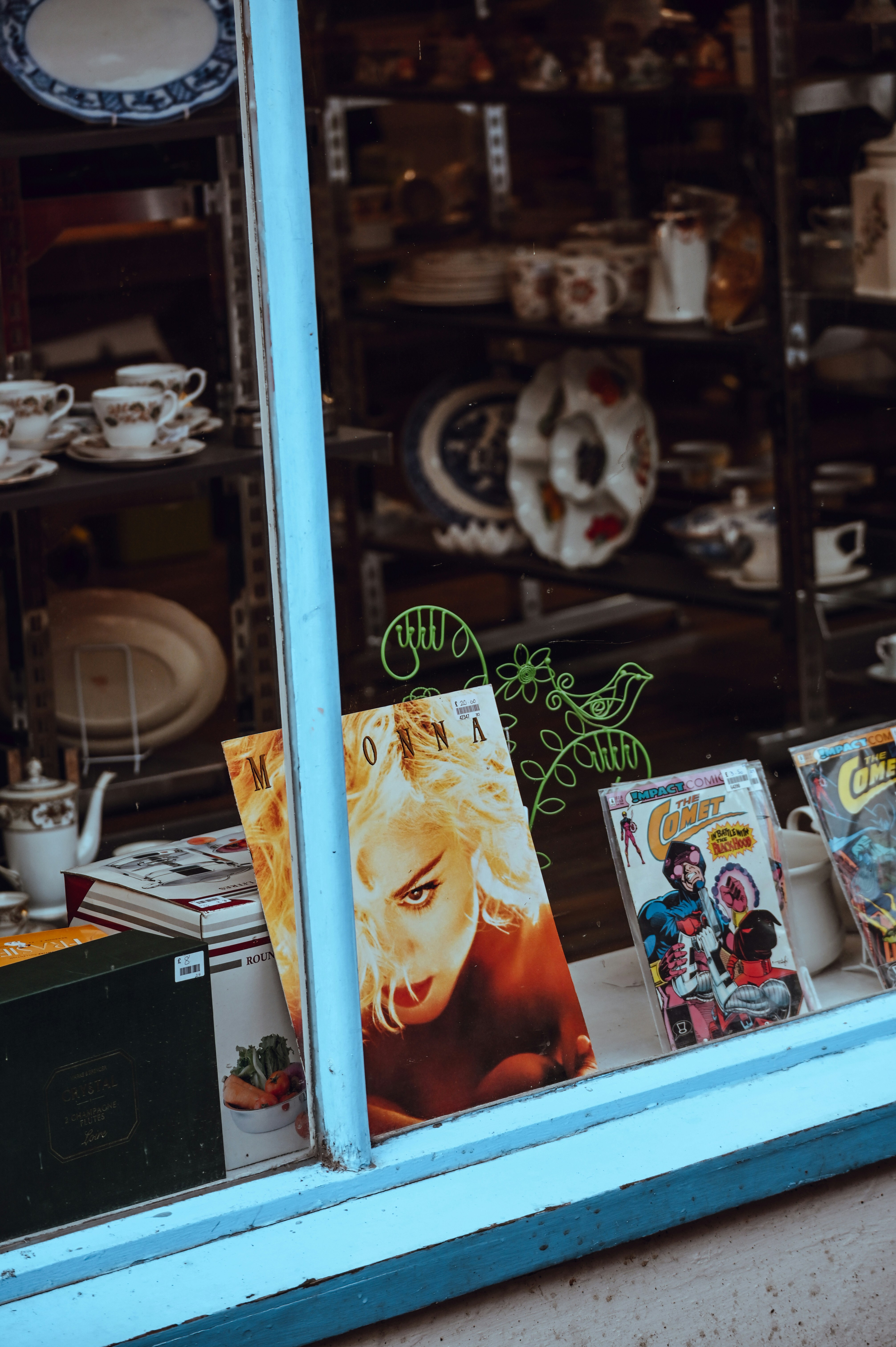 Madge doing her thing | Vintage magazines and collectibles displayed in shop window