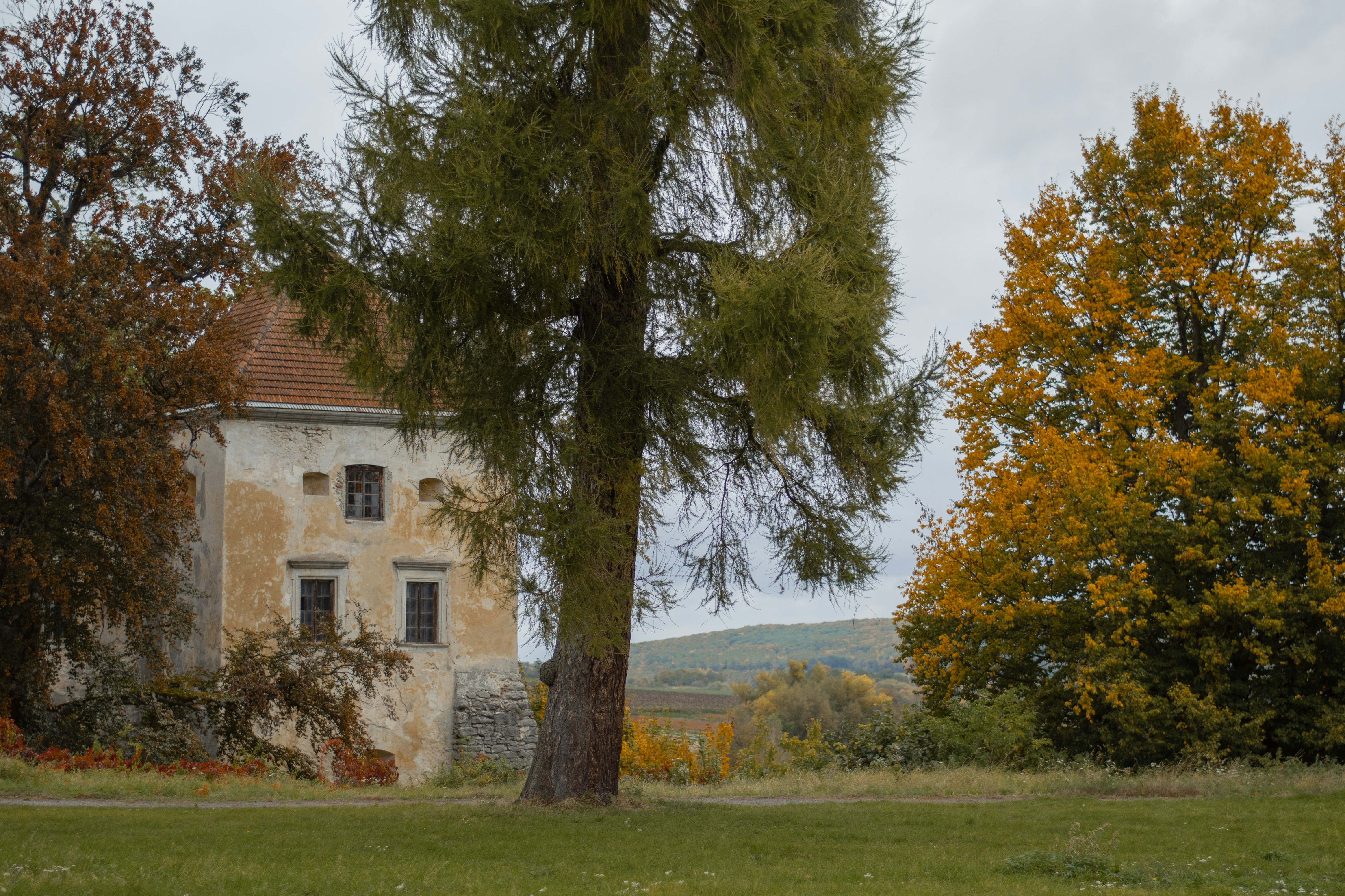 Old stone building with trees in autumn