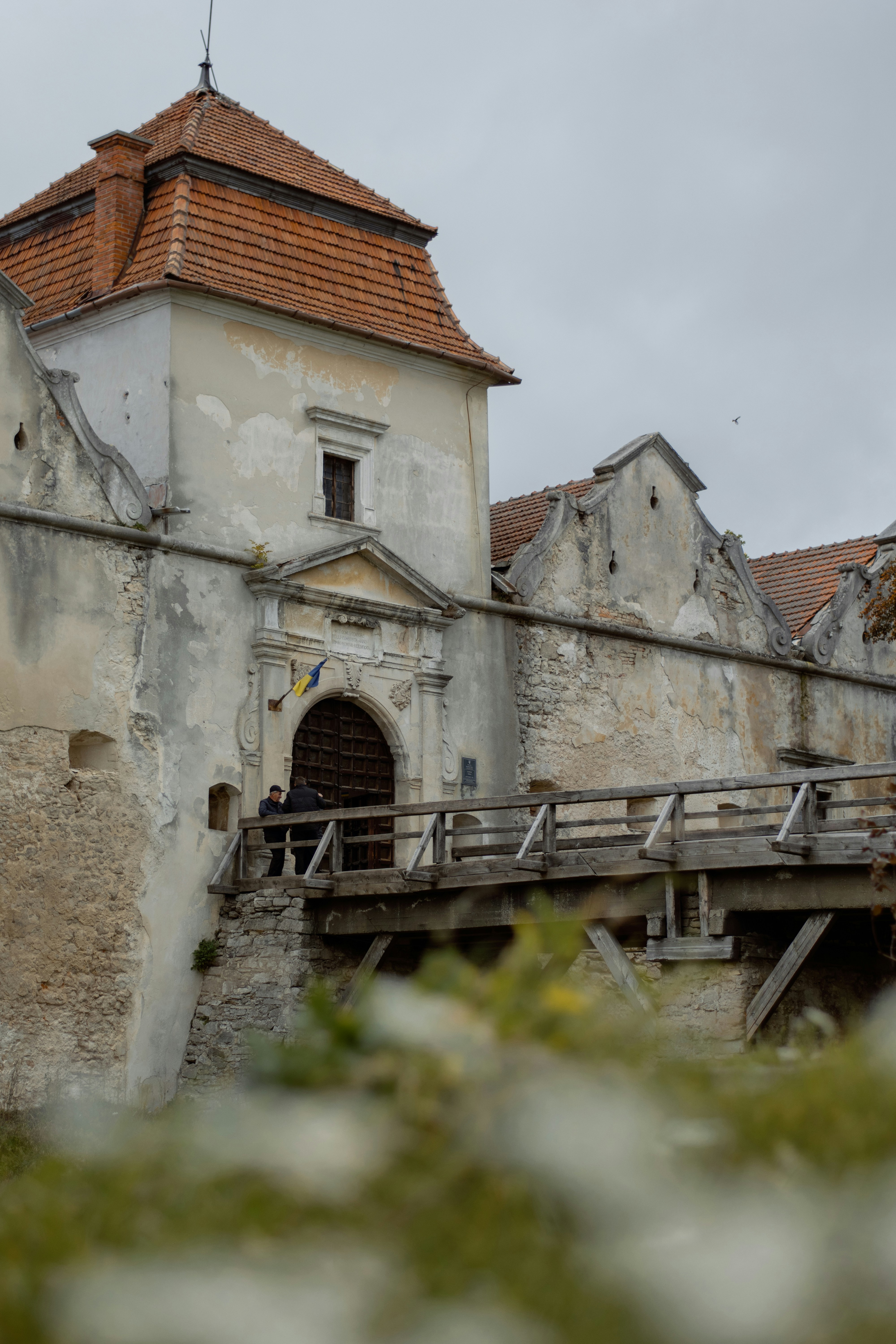Wooden bridge leading to an old stone castle entrance