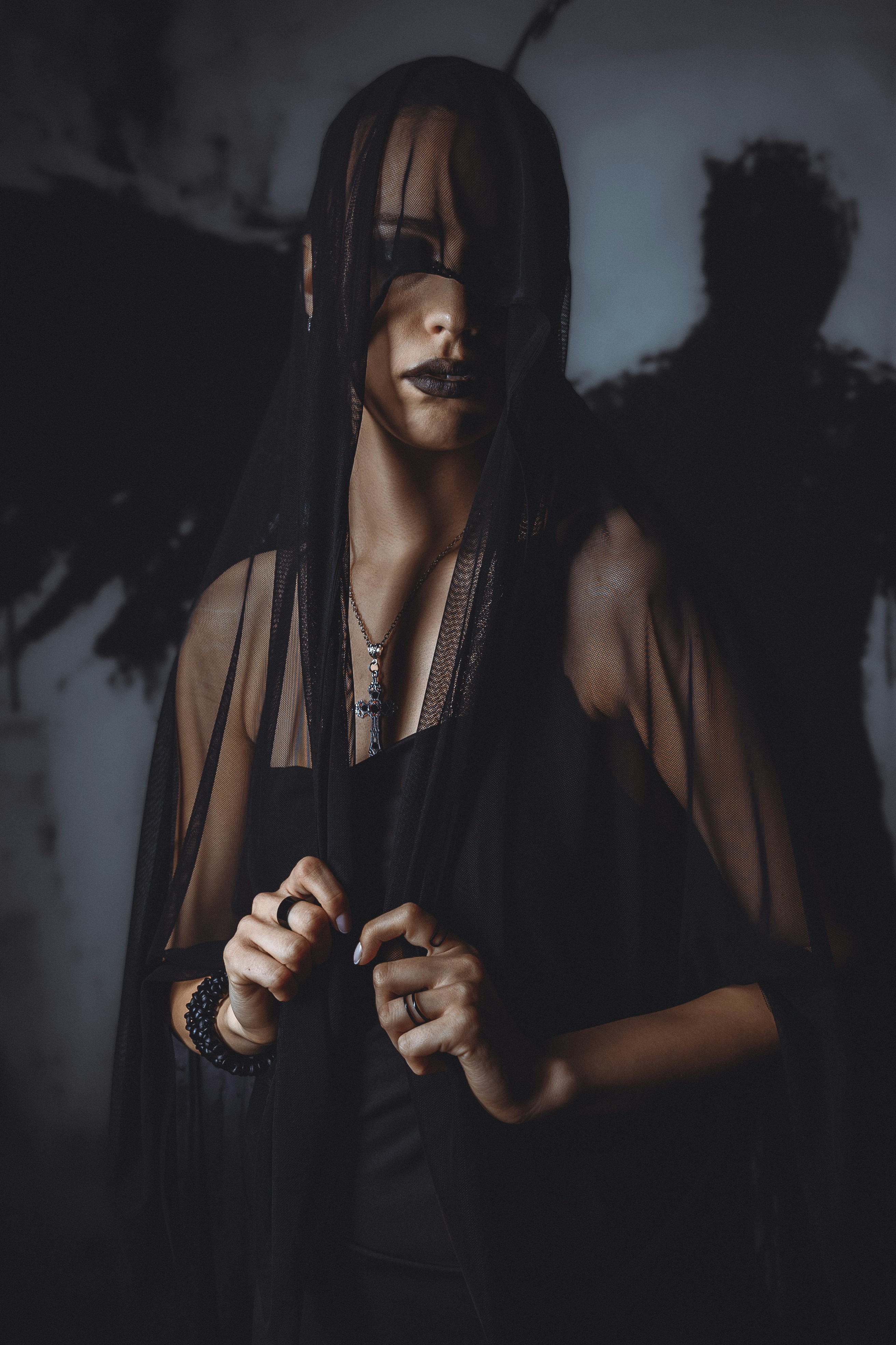 Woman in dark veil with dramatic makeup