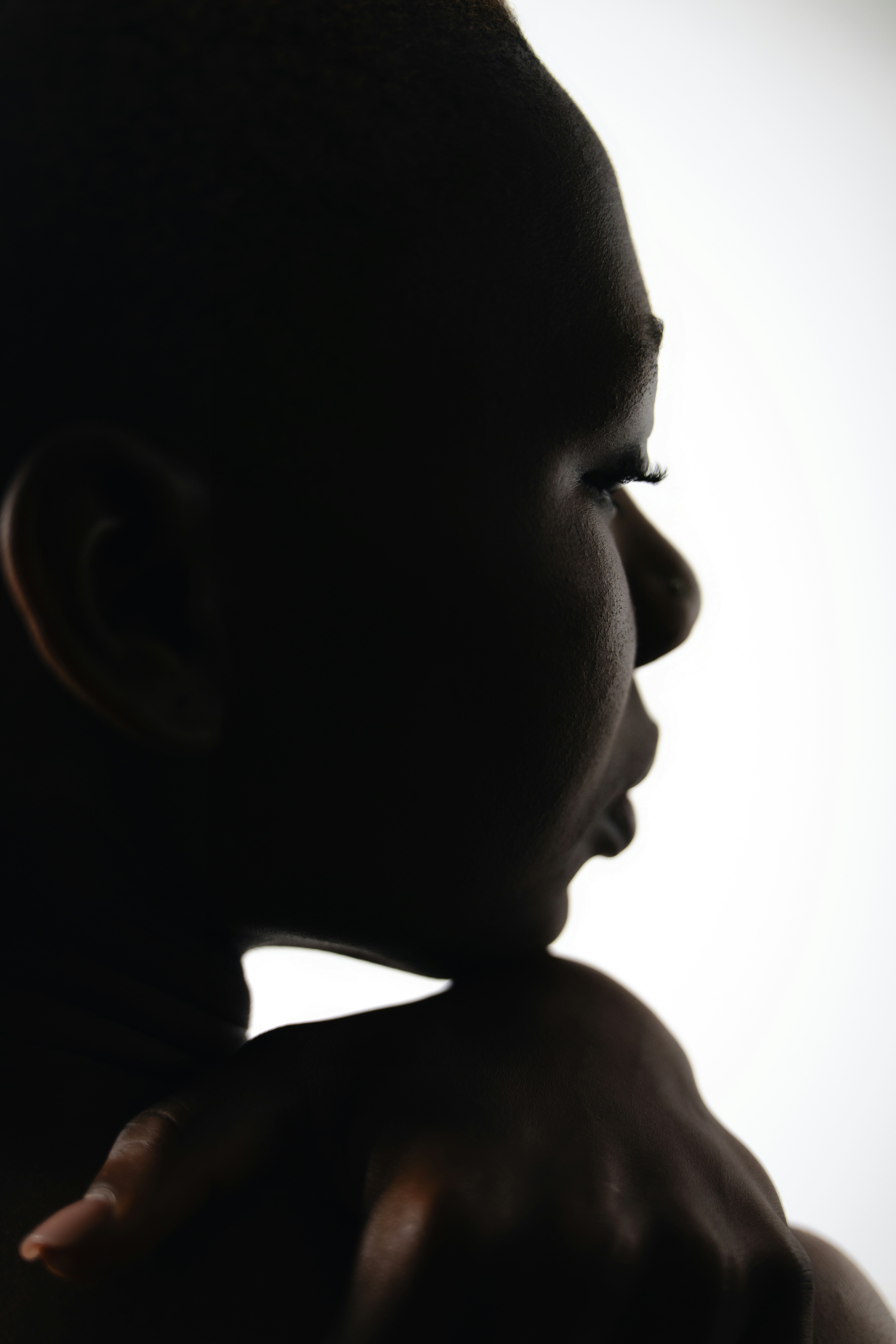 Silhouette of a child's profile on white background