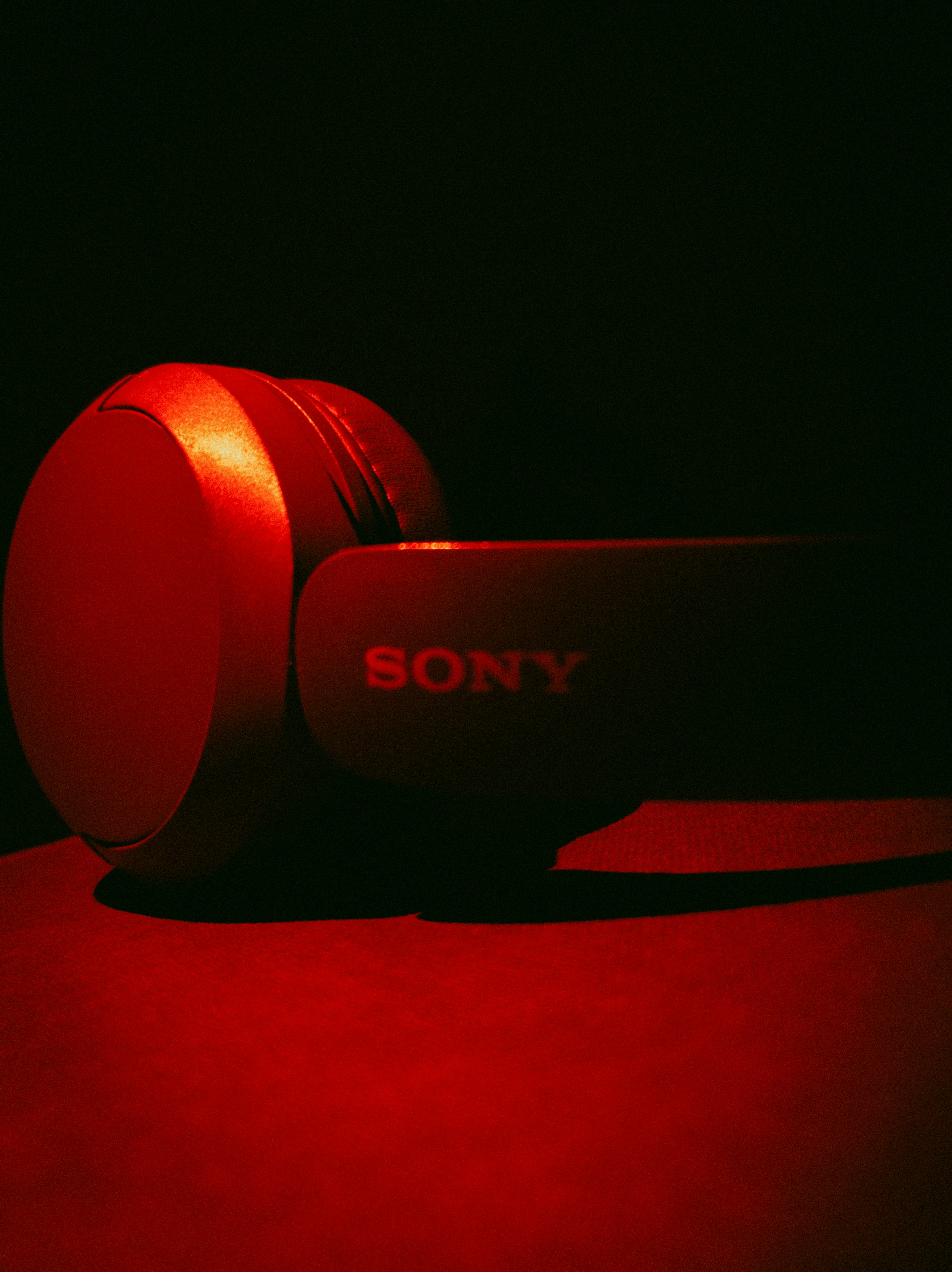 Sony headphone personal phototherapy | Red sony headphones on a dark surface
