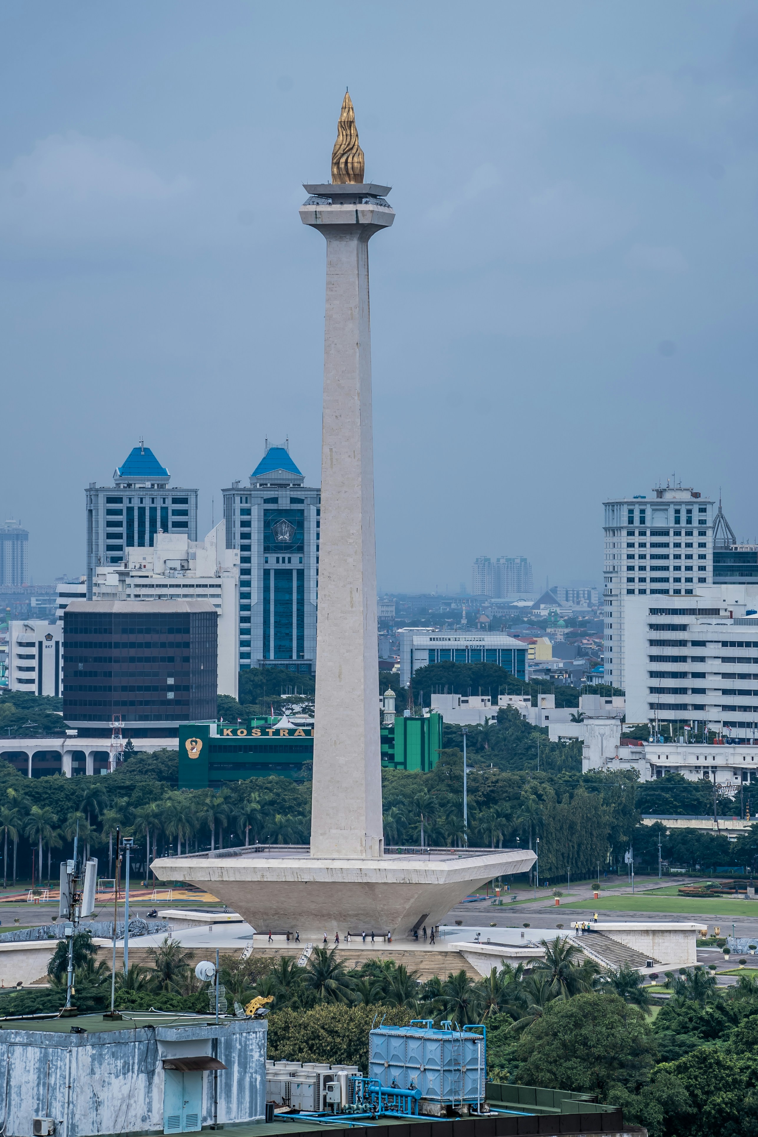 Monas monument in jakarta surrounded by city buildings