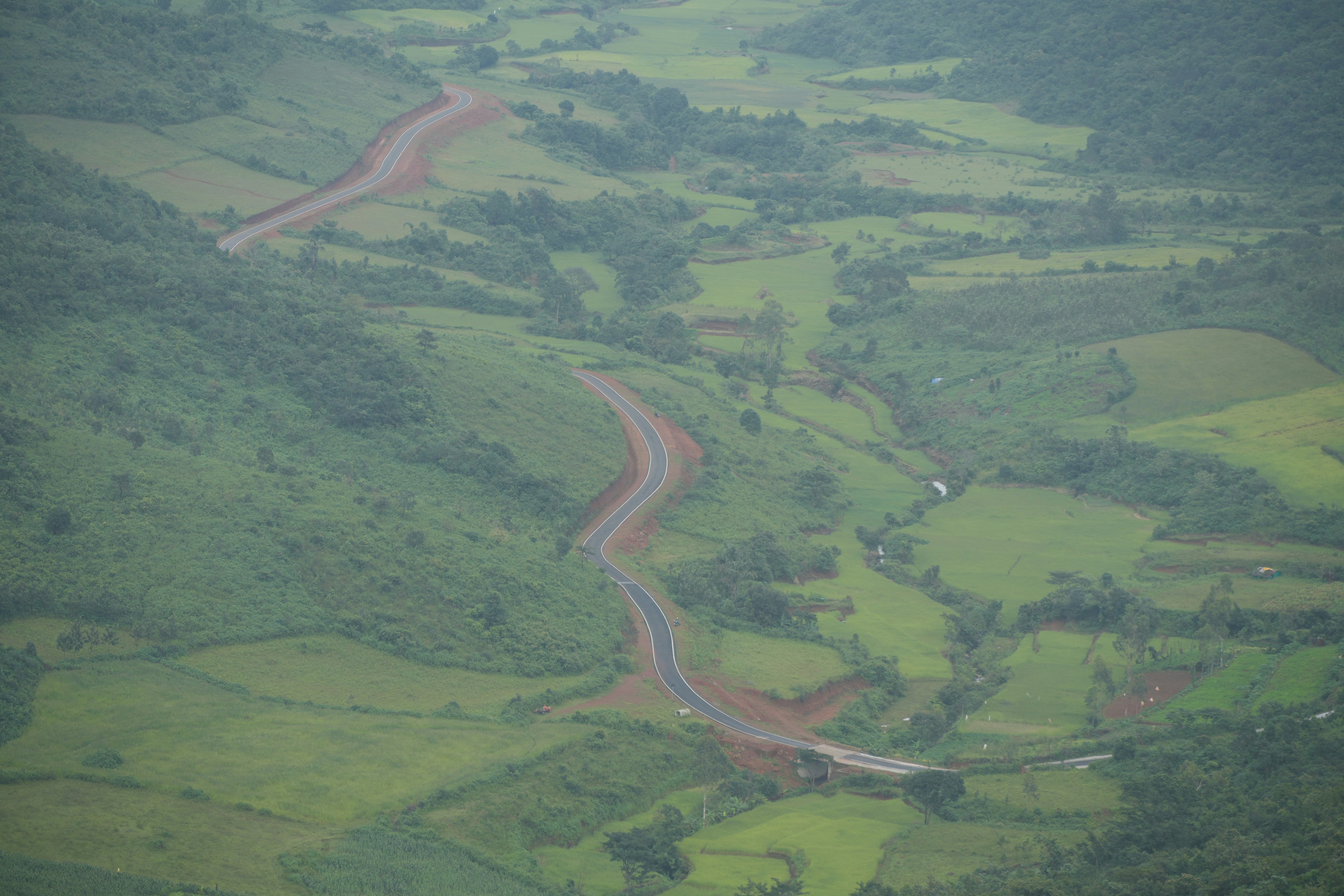 Serpentine Road Wends Through Patchwork Valleys