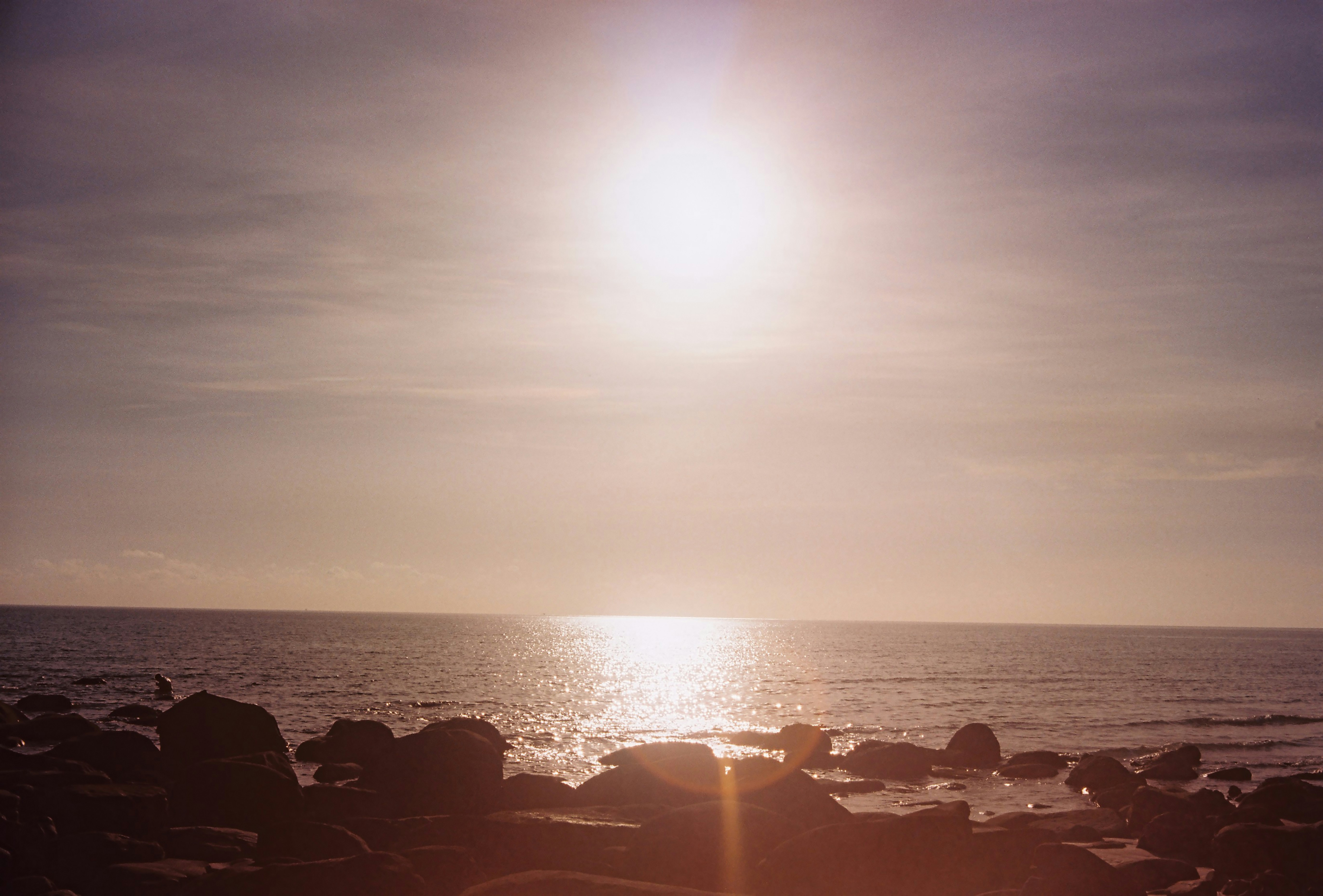 Sunset at the sea | Sun setting over a rocky ocean shoreline