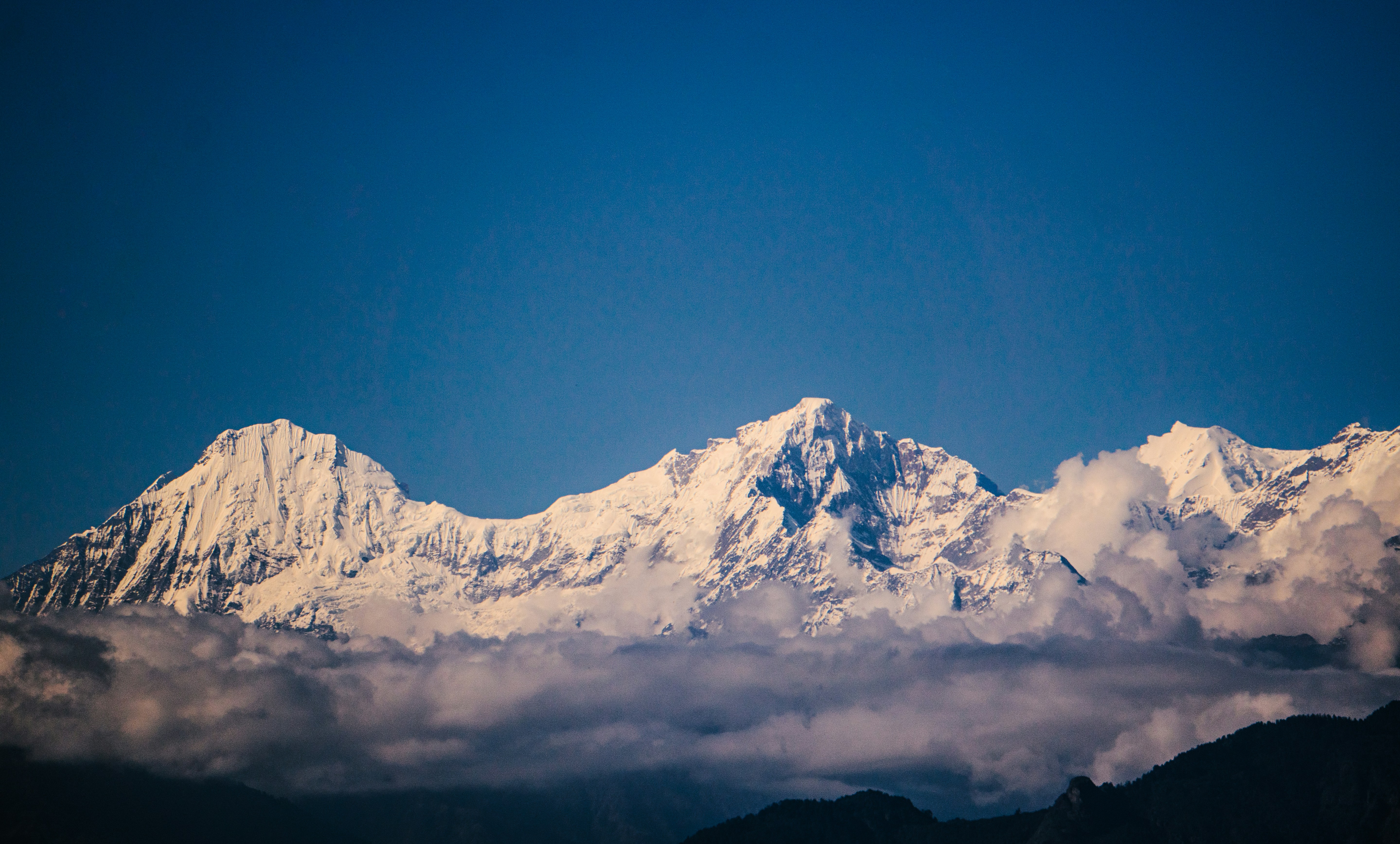 Snow-capped mountains under a clear blue sky.