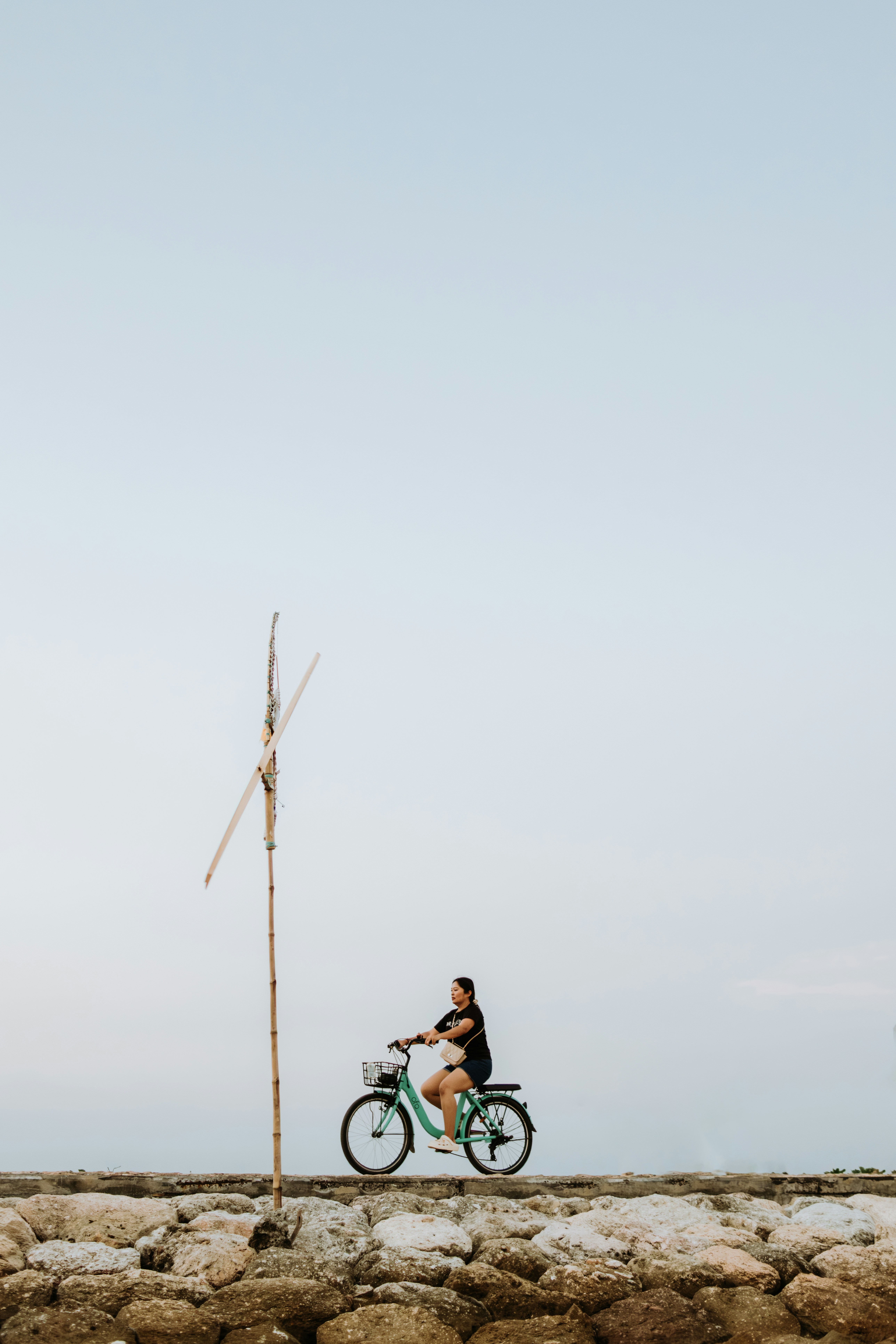 Woman riding a bicycle on a stone path