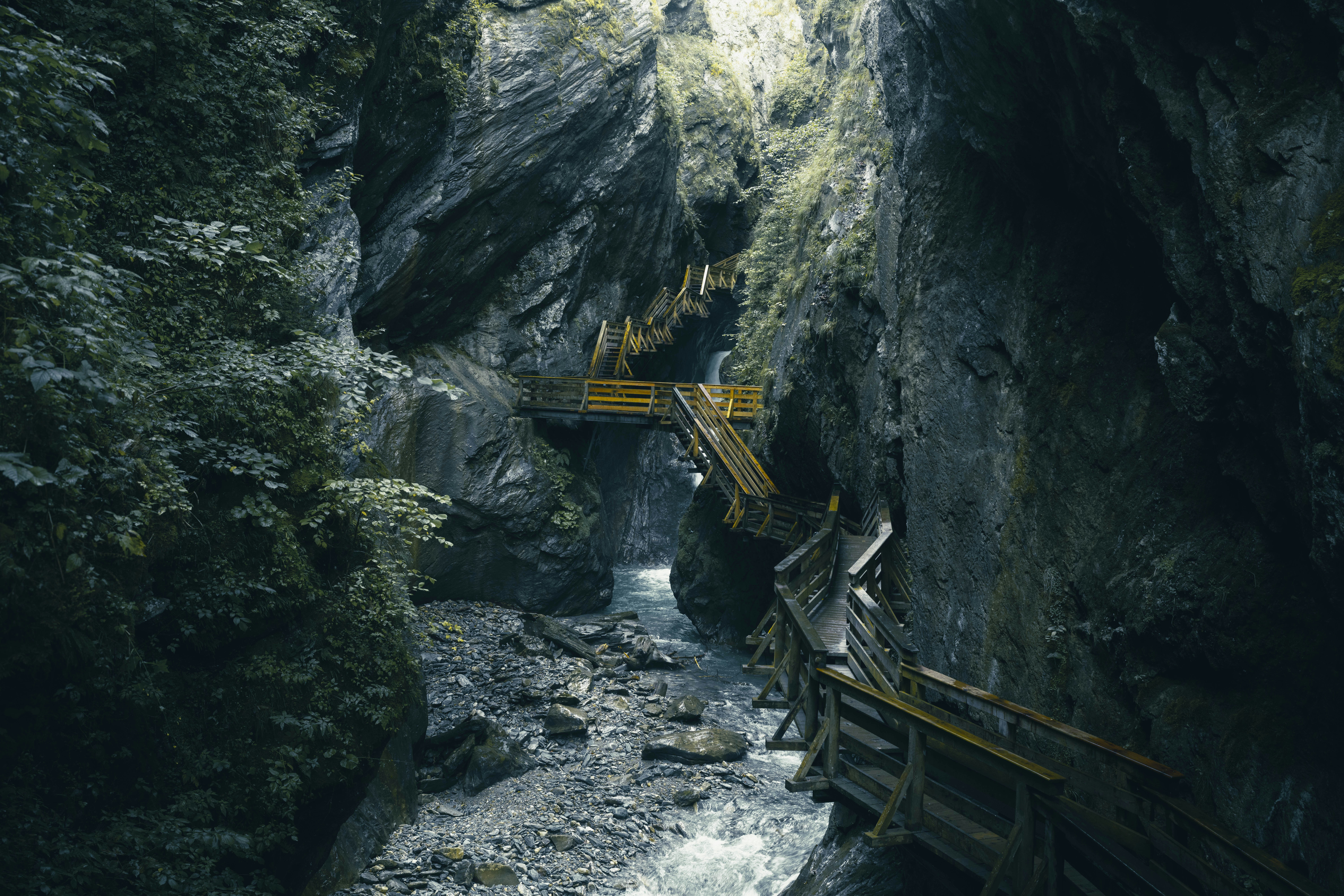 Wooden walkways through a rocky gorge with a stream
