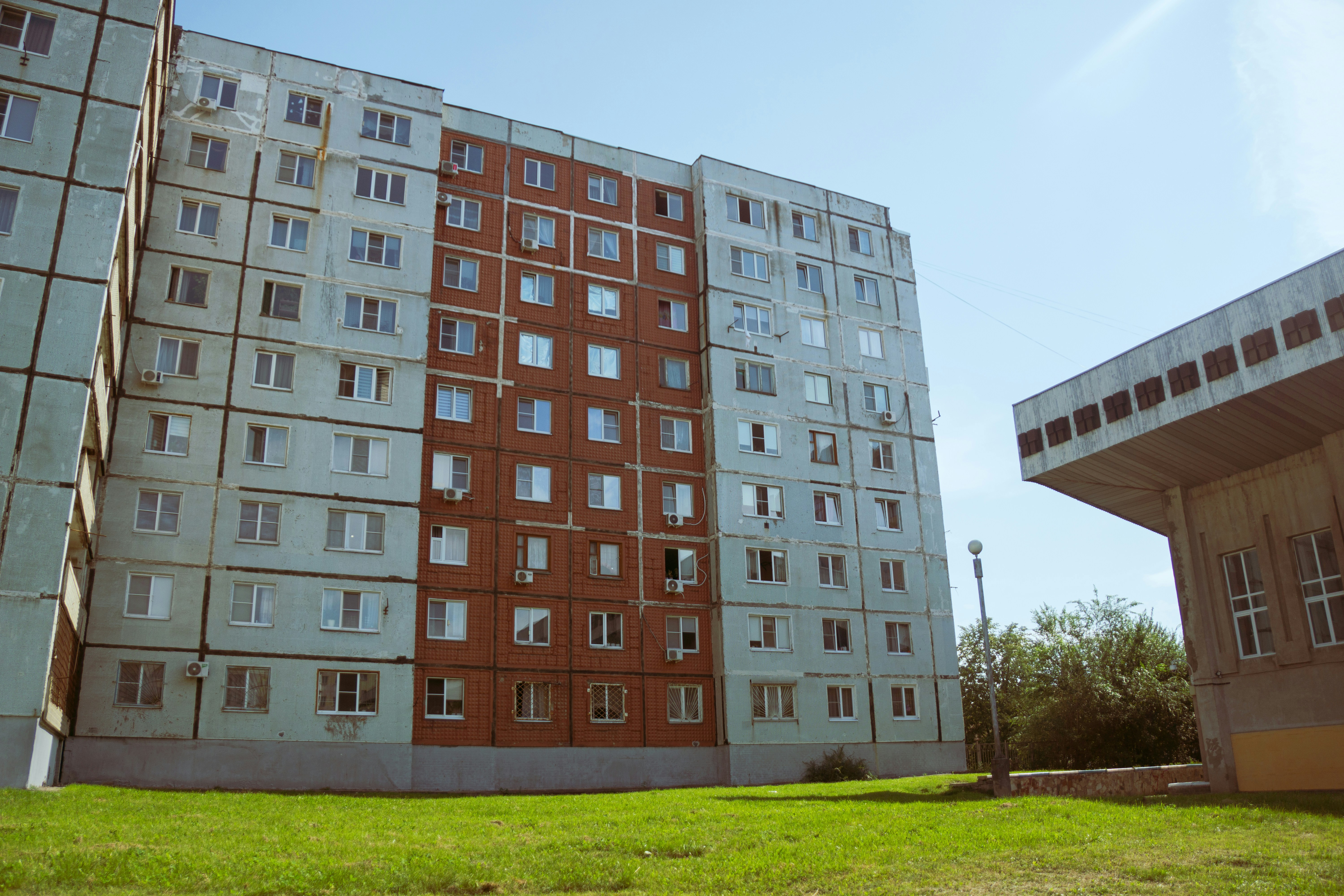 Apartment buildings with a grassy lawn outside.
