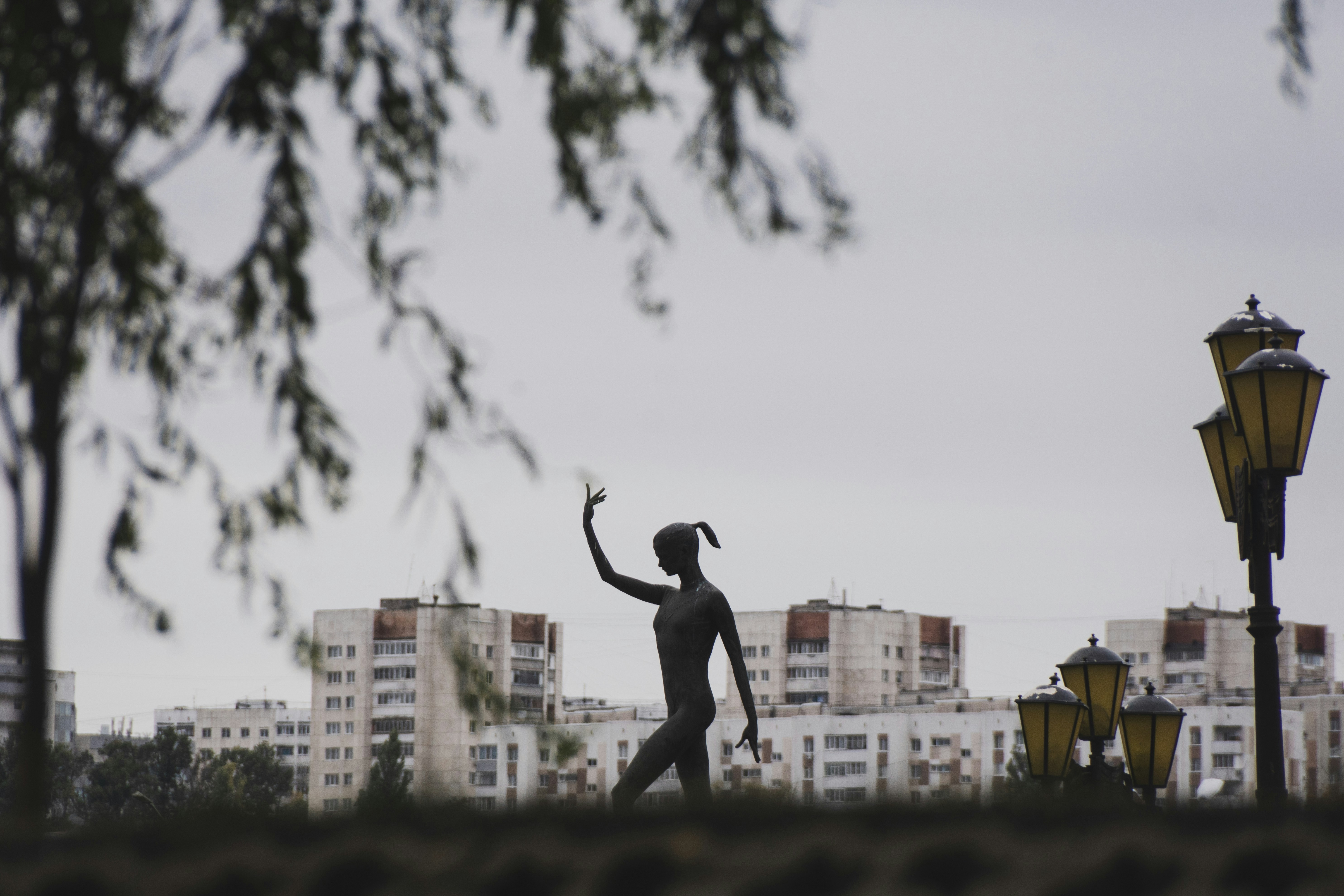 Silhouette of a woman statue in a park