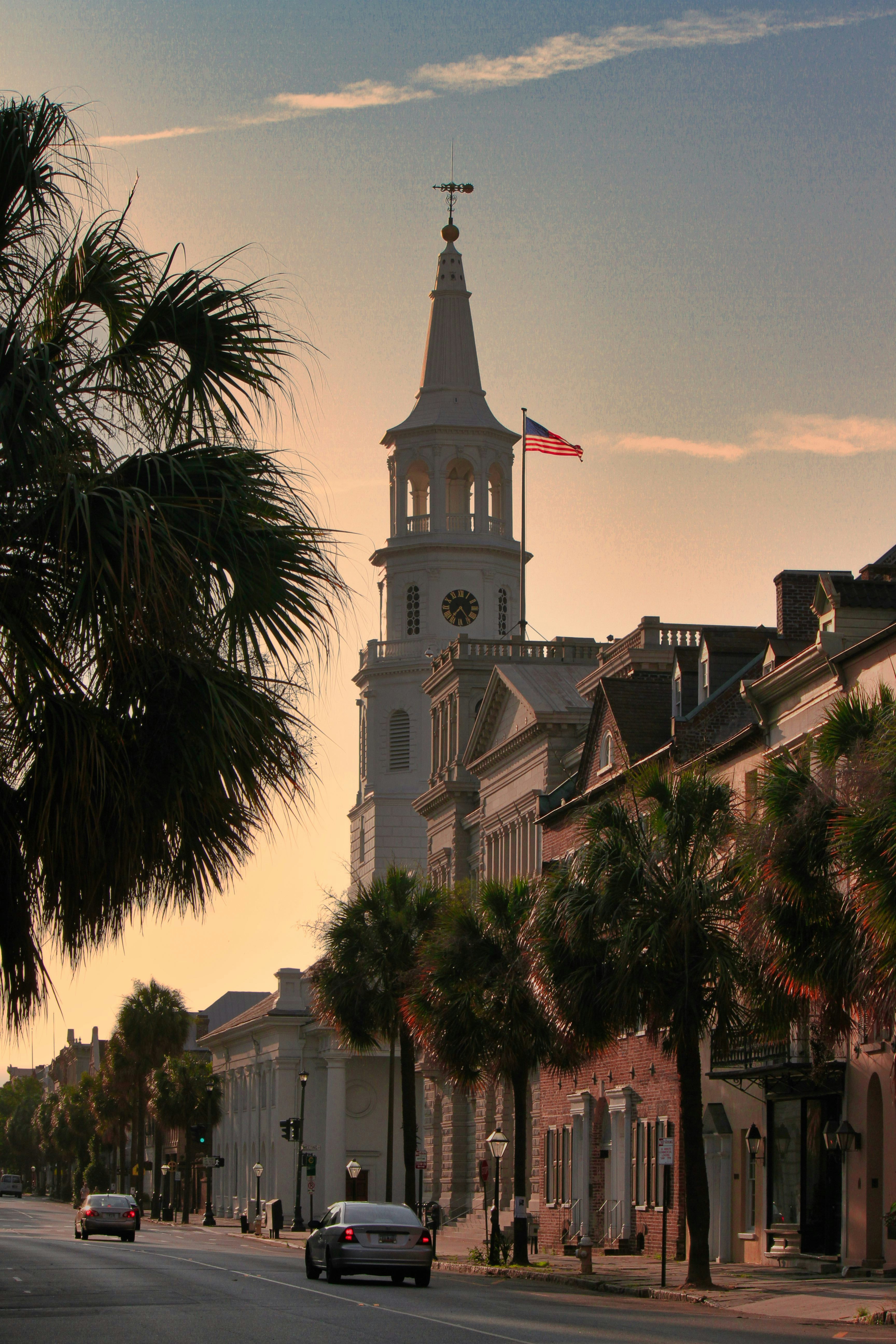 Historic church steeple with palm trees and street