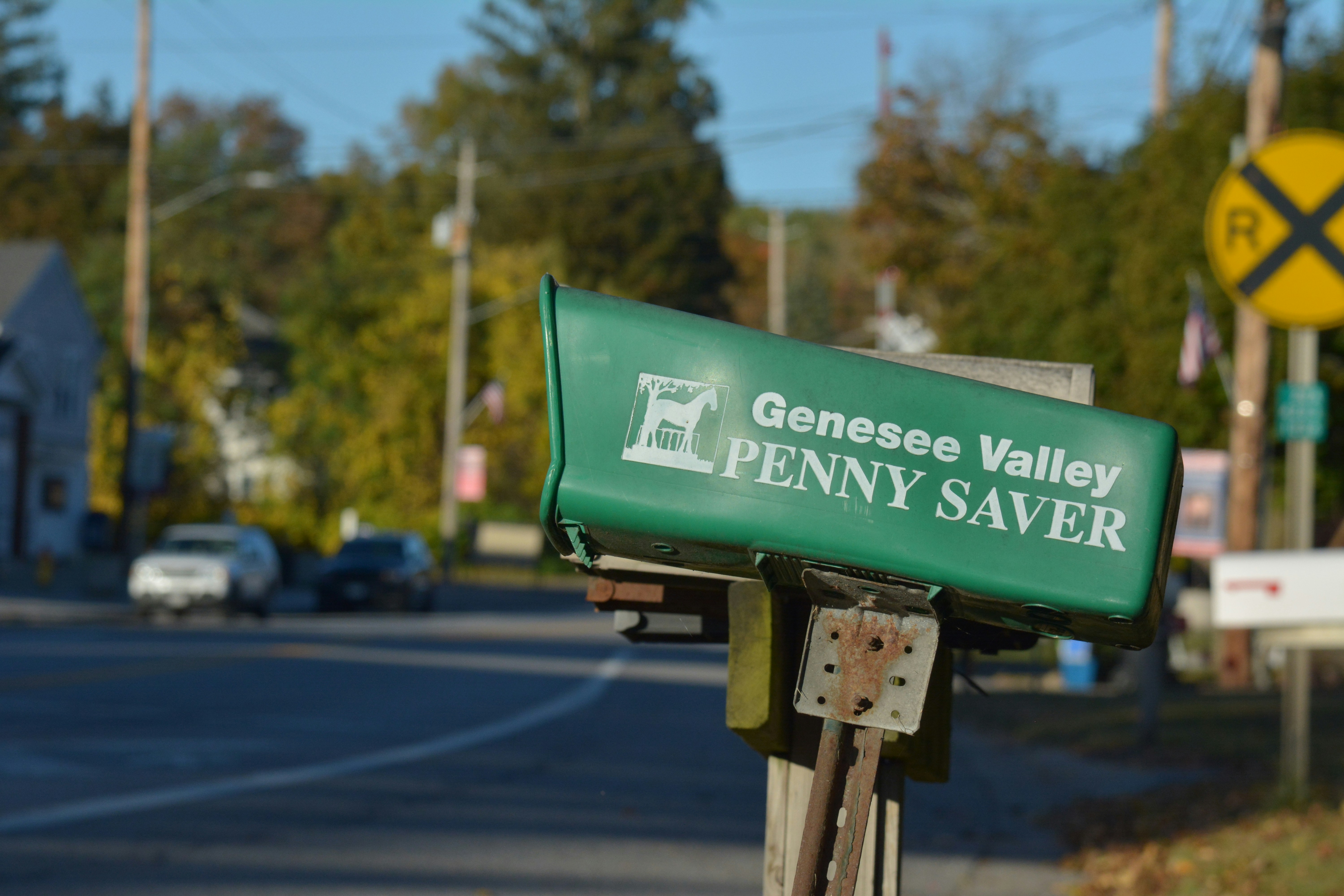 Green mailbox with "genesee valley penny saver" text.
