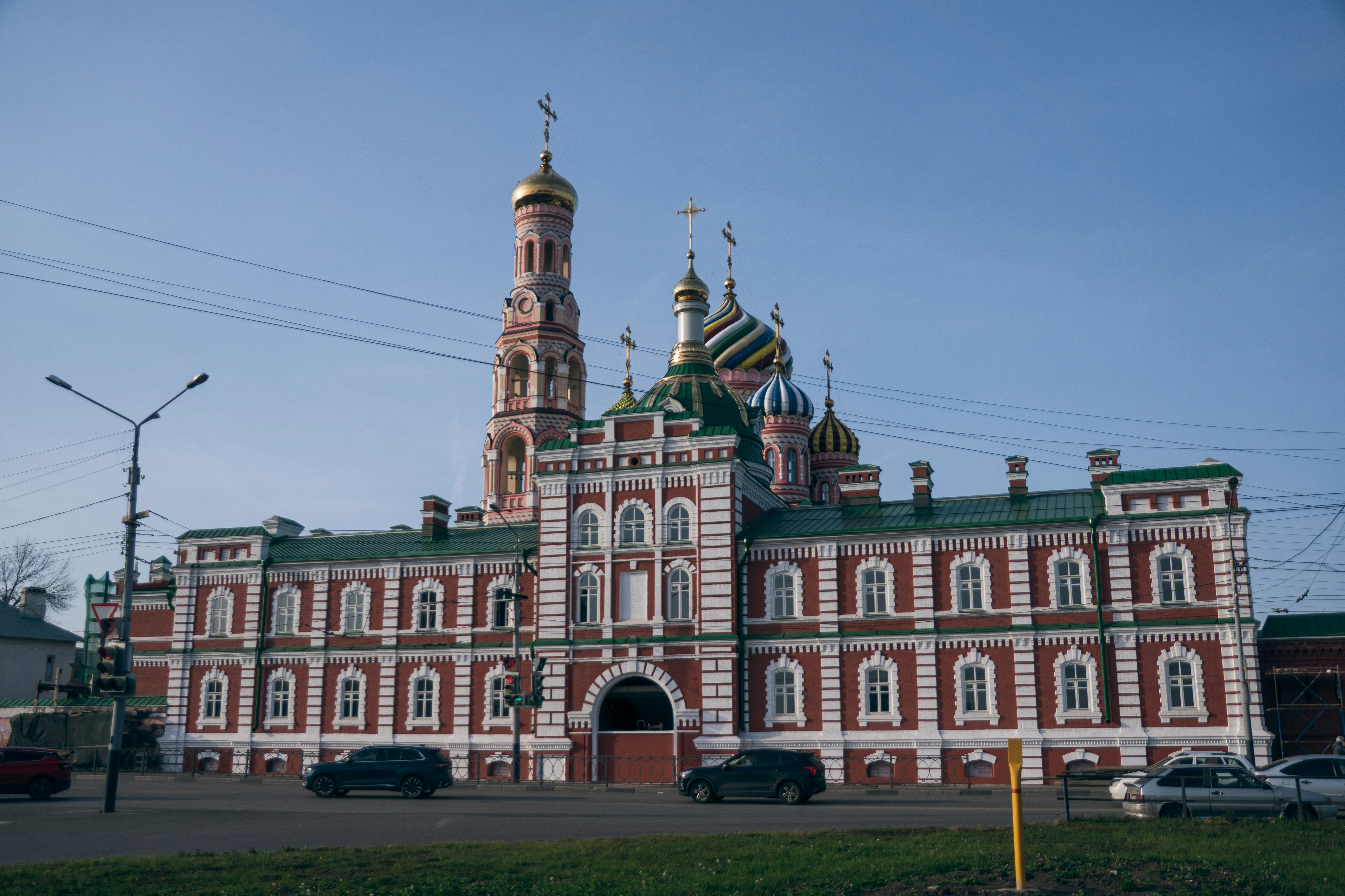 Ornate historic building with golden domes and bell tower.