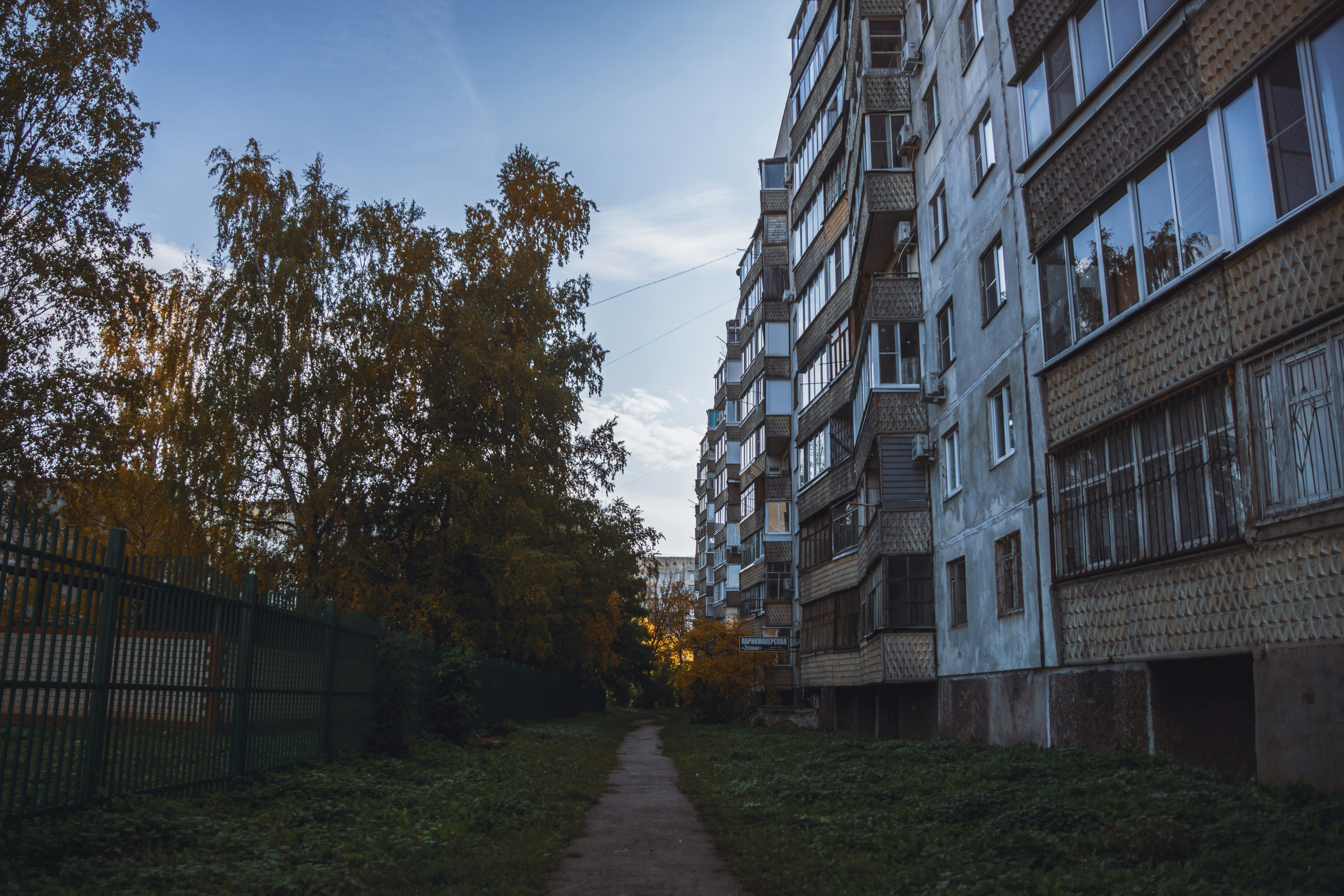 Apartment building with trees and a sidewalk