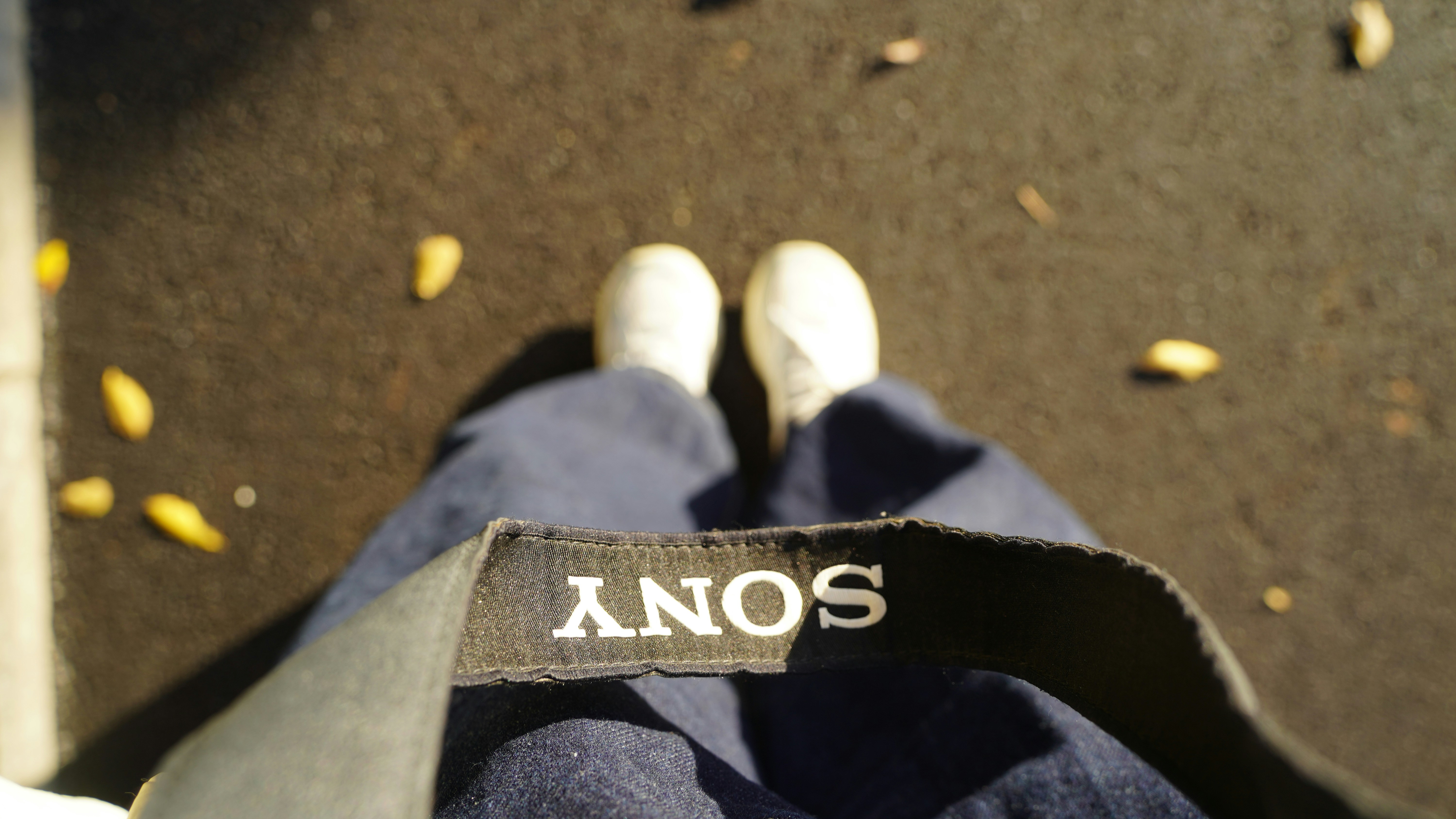 Sony logo on dark fabric with white shoes