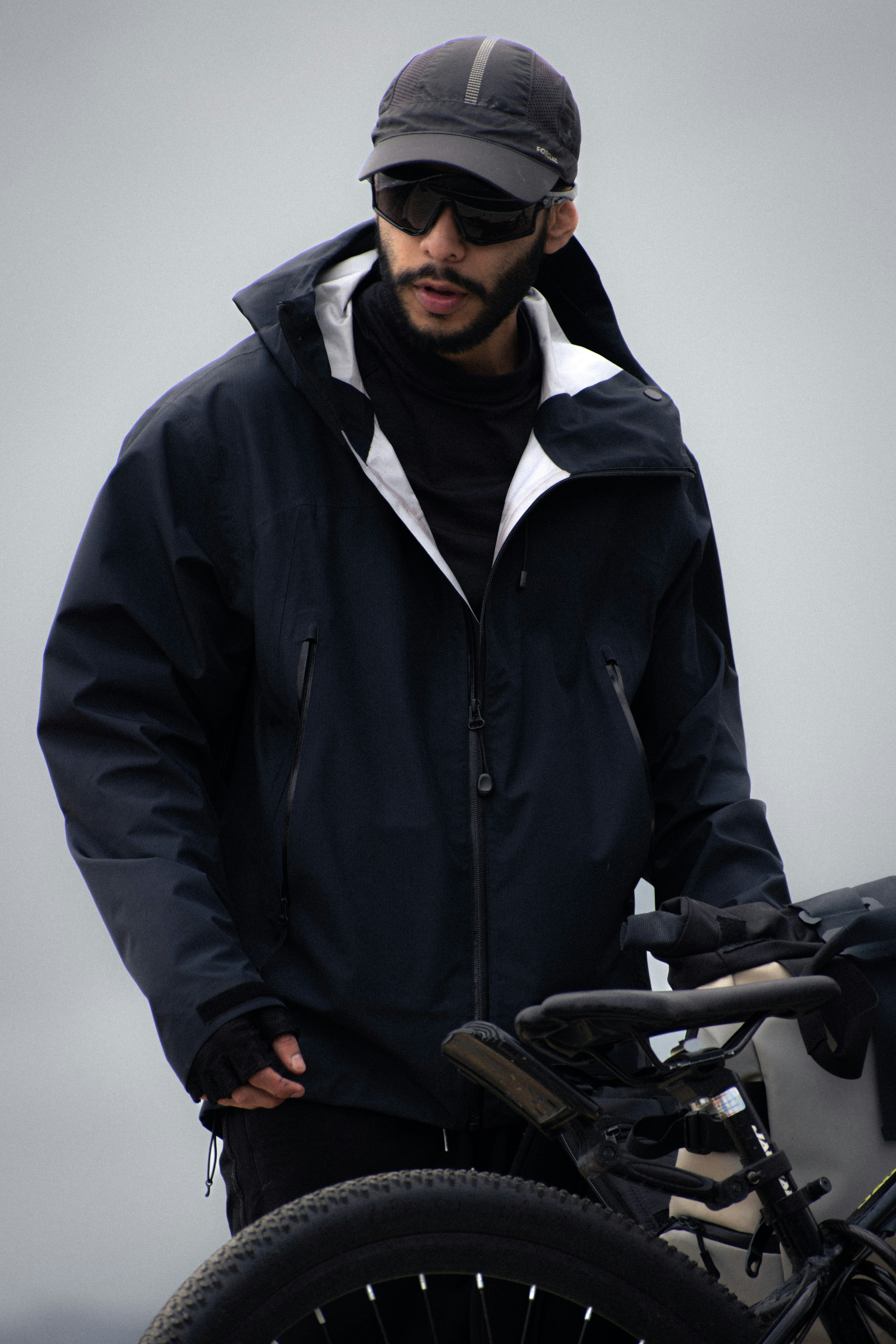 Man in dark jacket with bicycle