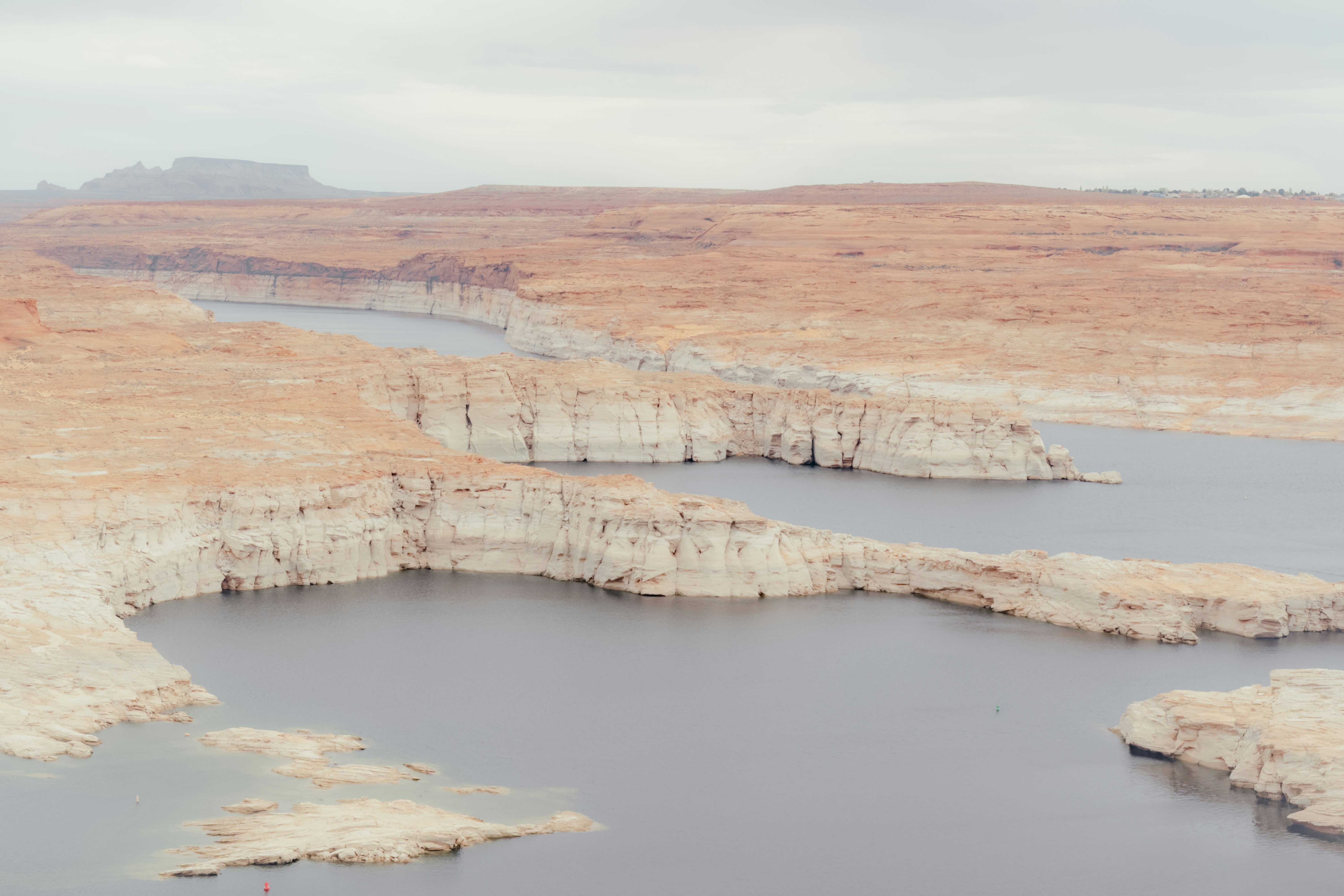 Layered cliffs above the water | Desert landscape with winding river and rocky cliffs