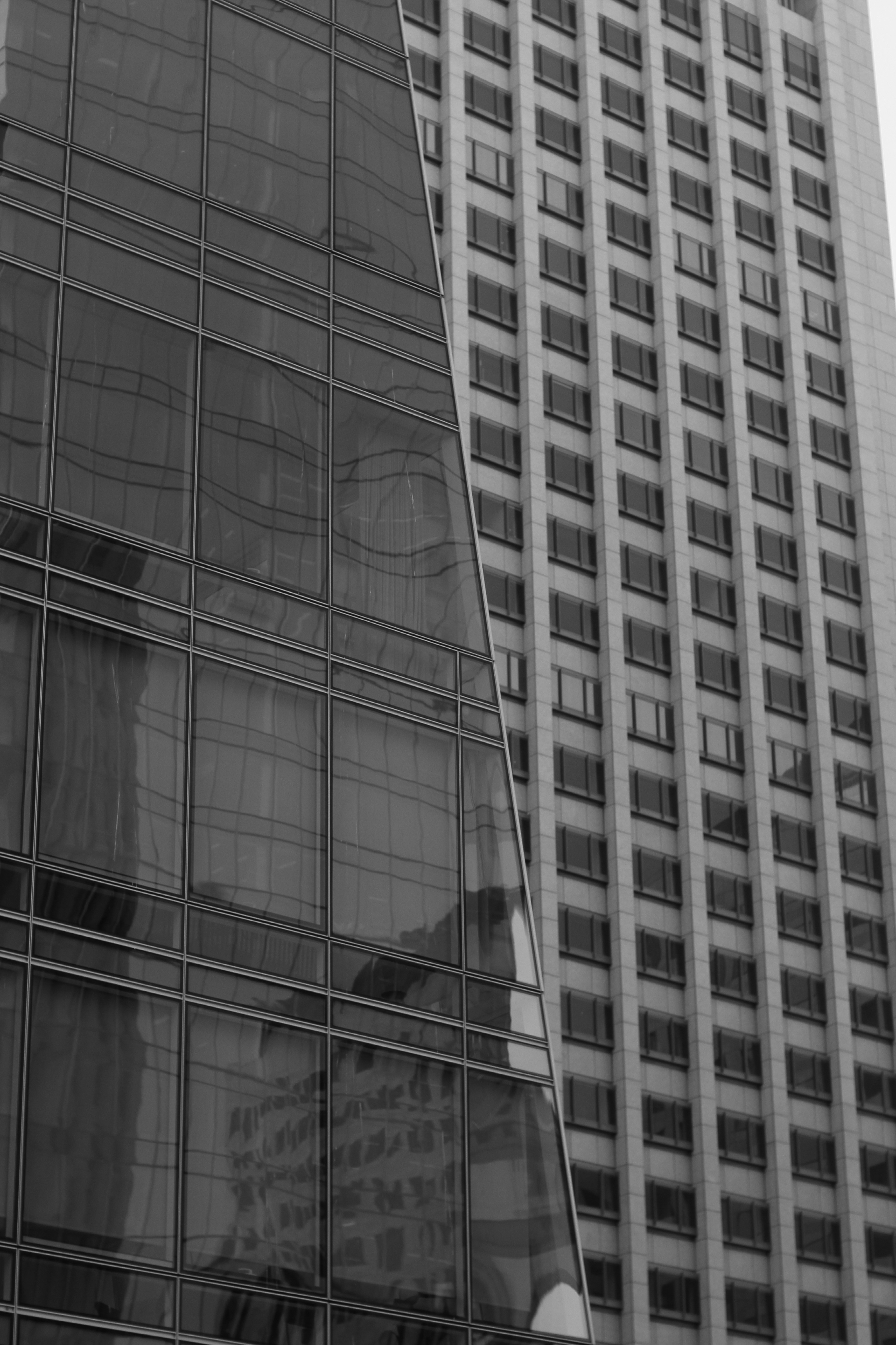 Two modern buildings with glass and concrete facades