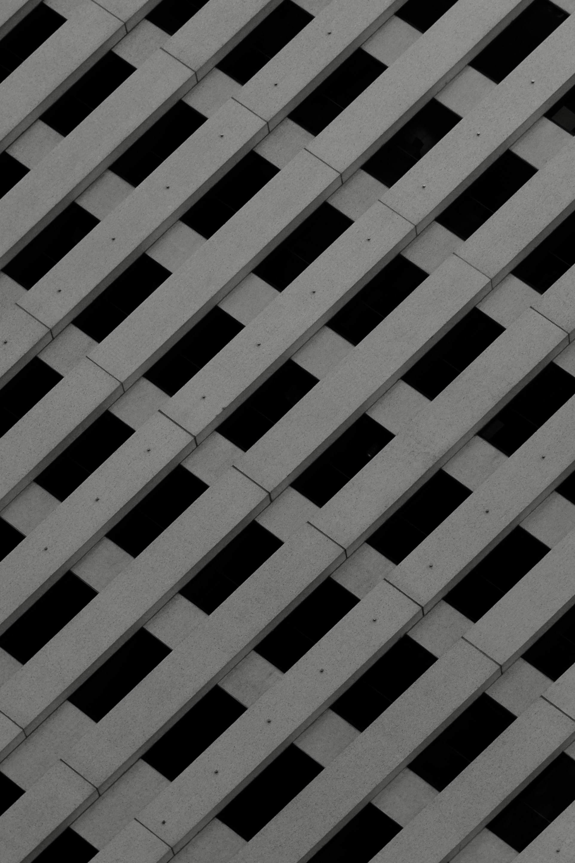 Diagonal pattern of gray concrete slats and black openings