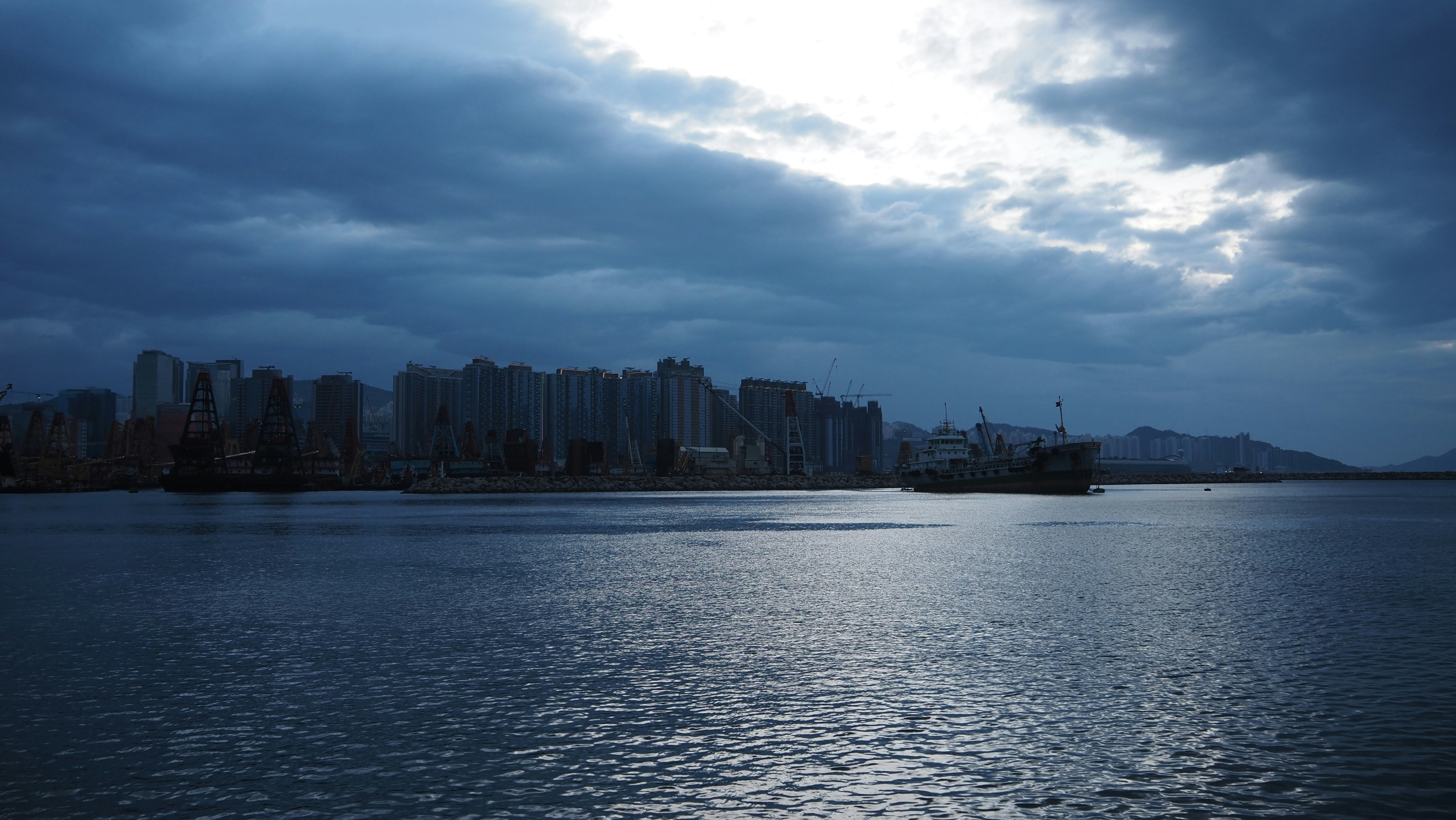 City skyline across a body of water at dusk