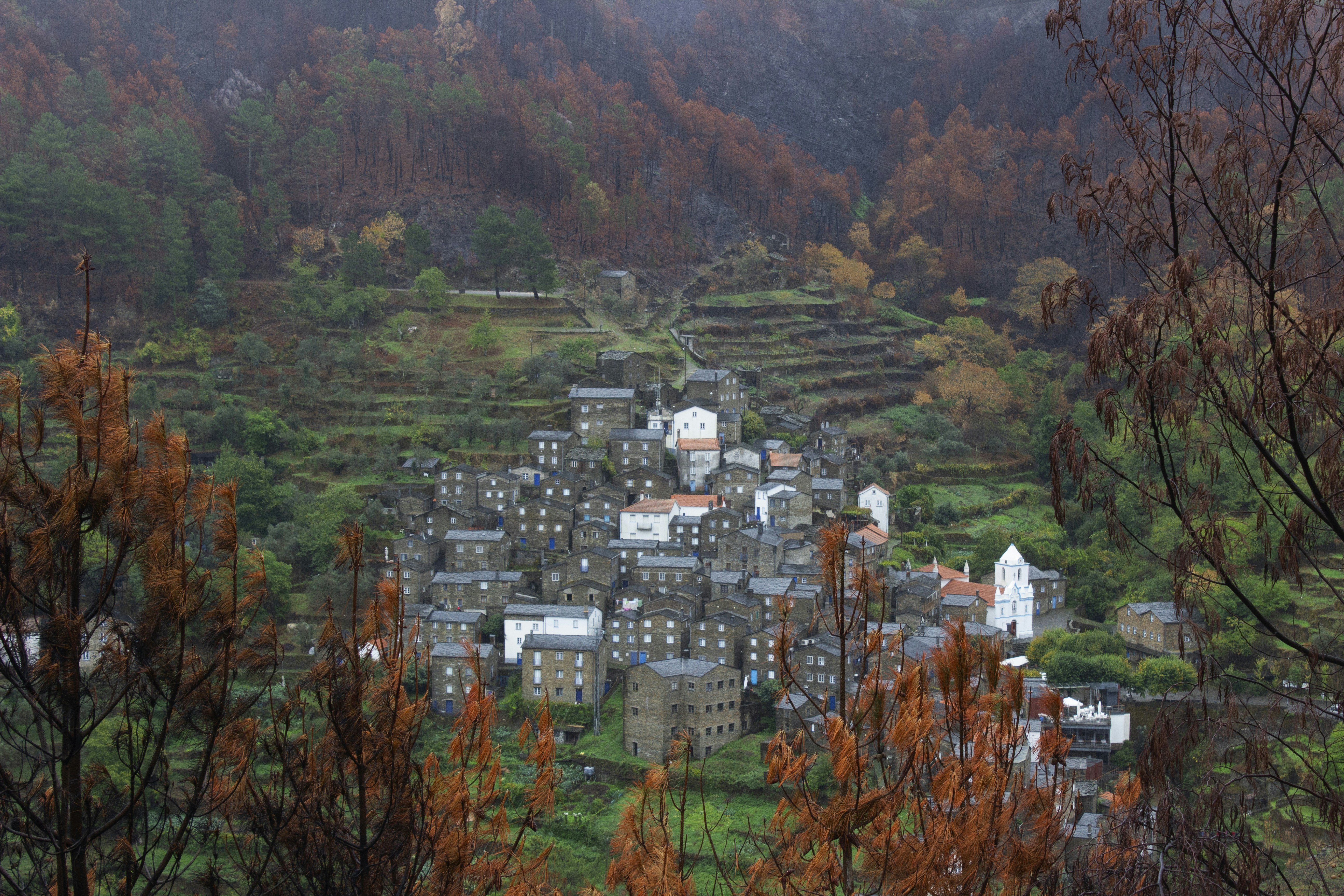 Piódão | Stone houses nestled in a terraced hillside village.
