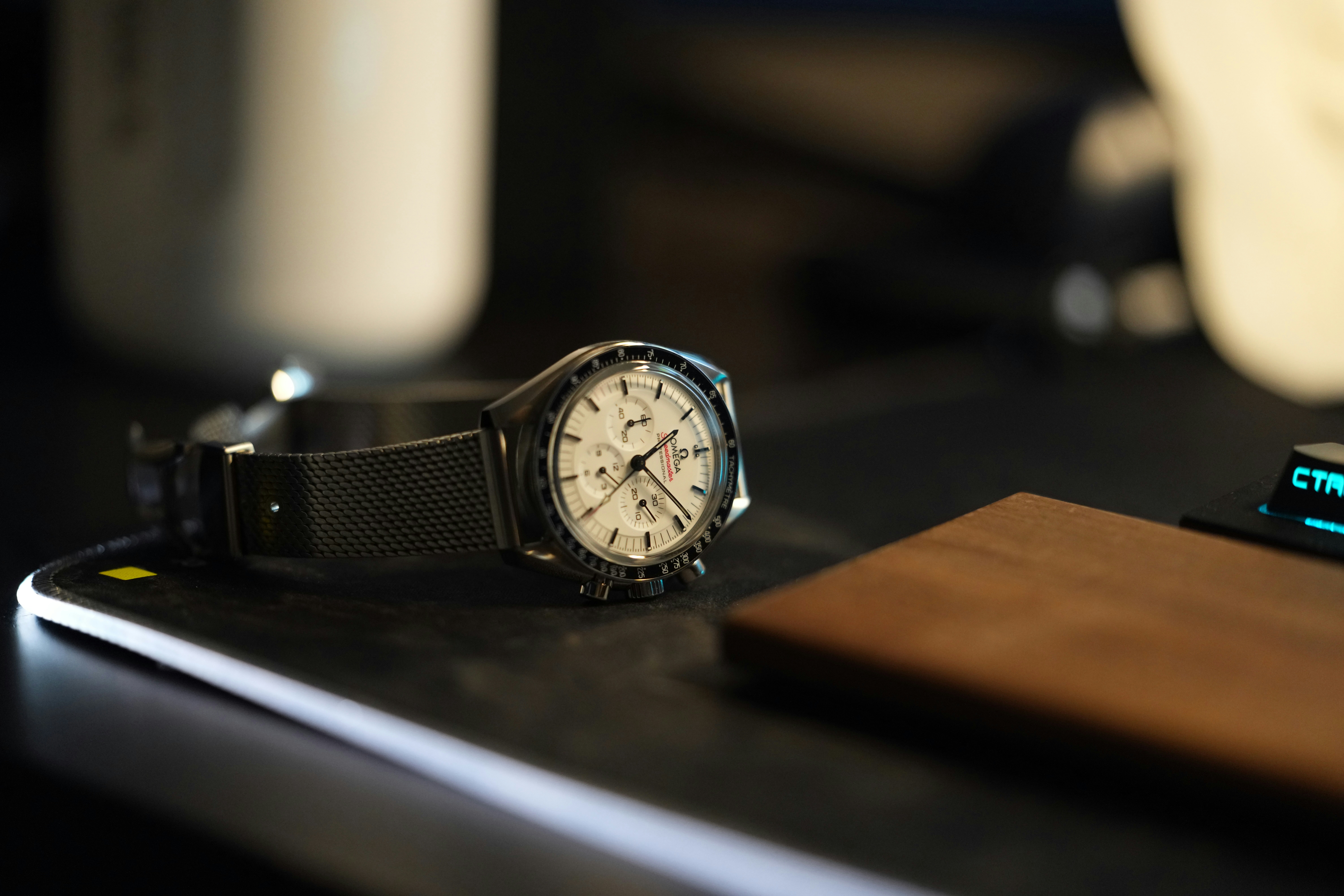 Close-up of a wristwatch on a dark surface.
