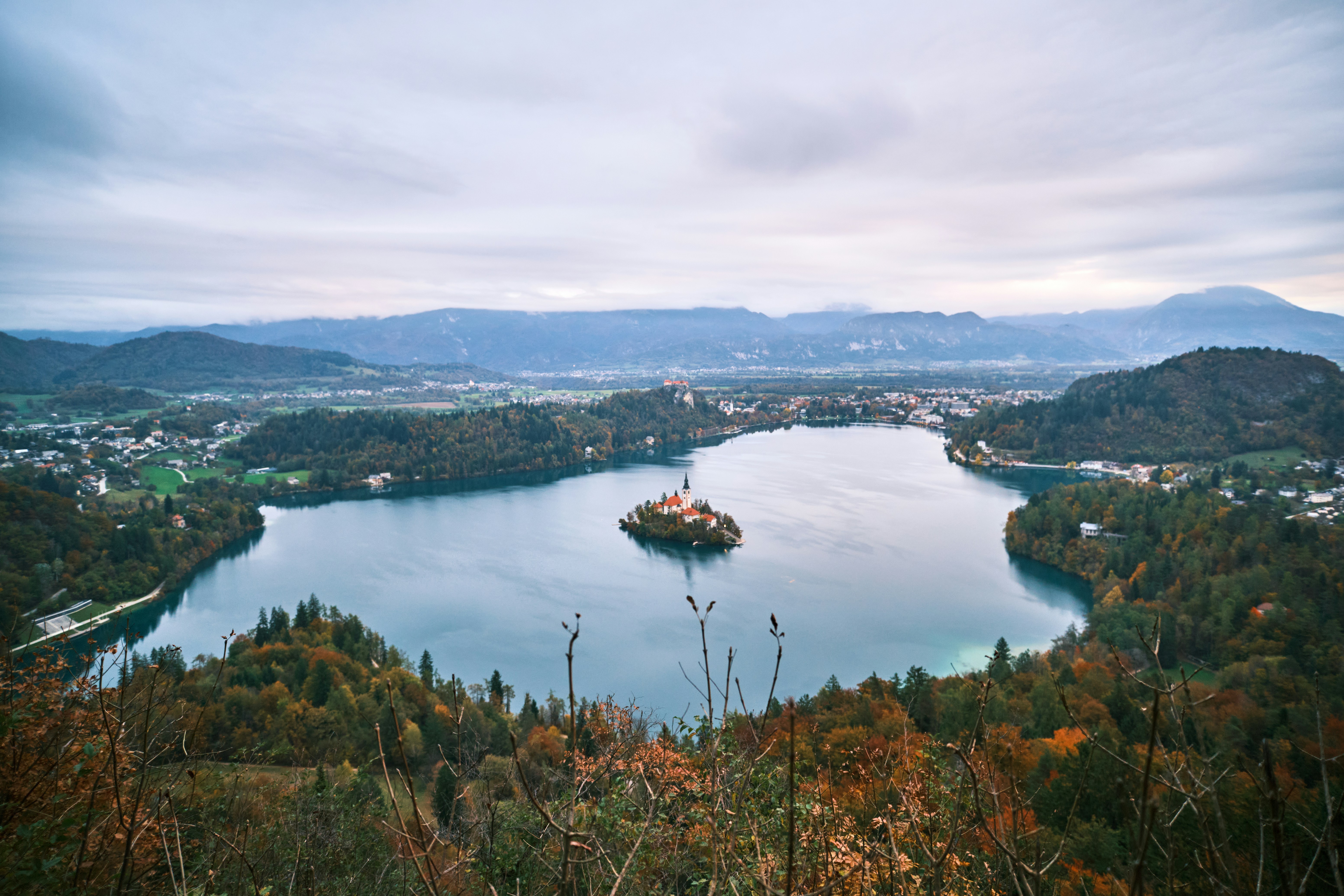 Lake with an island and castle, surrounded by hills.