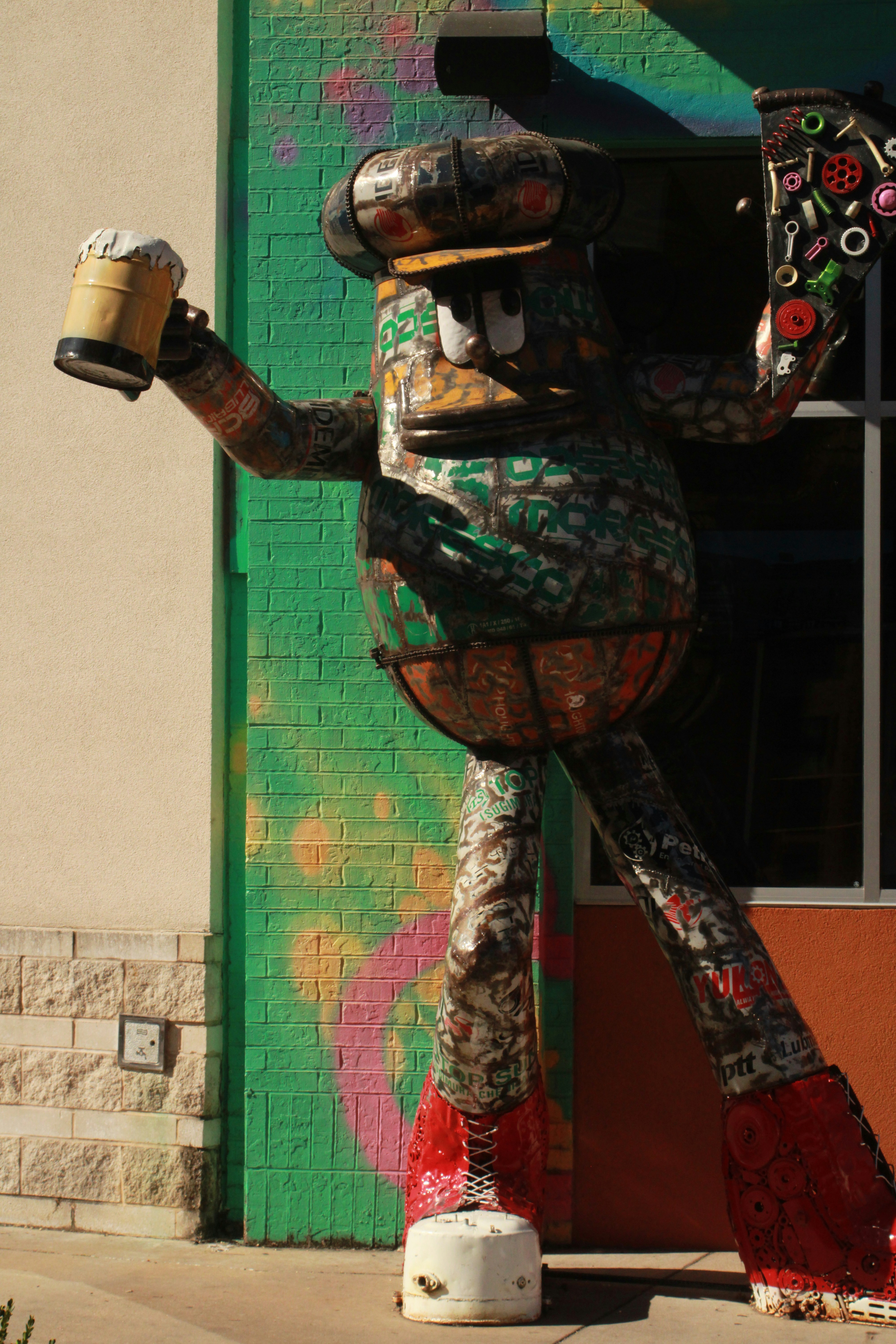 Whimsical Metal Mascot Cheers with Pizza and Beer