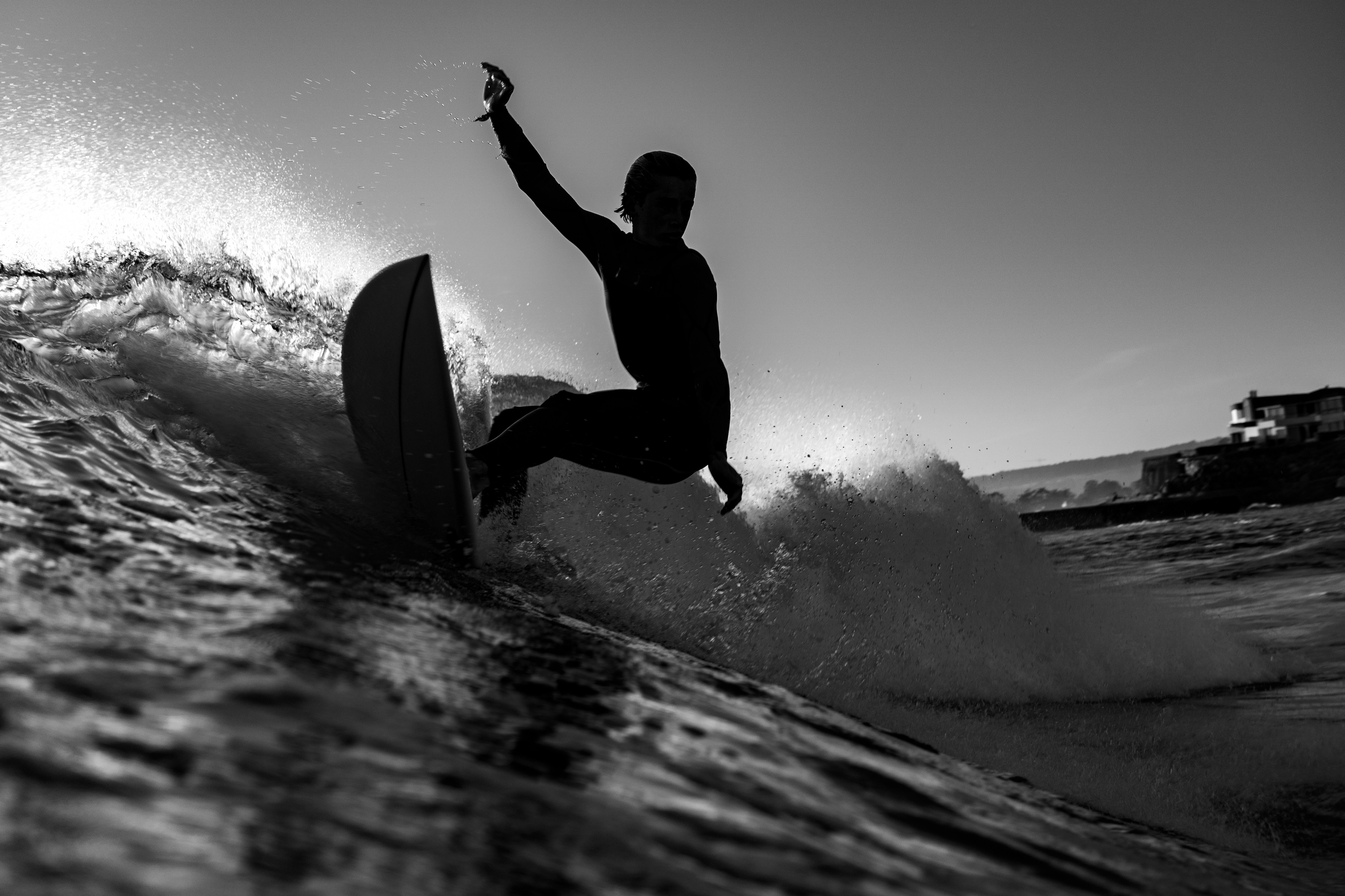 Surfer riding a wave during the day