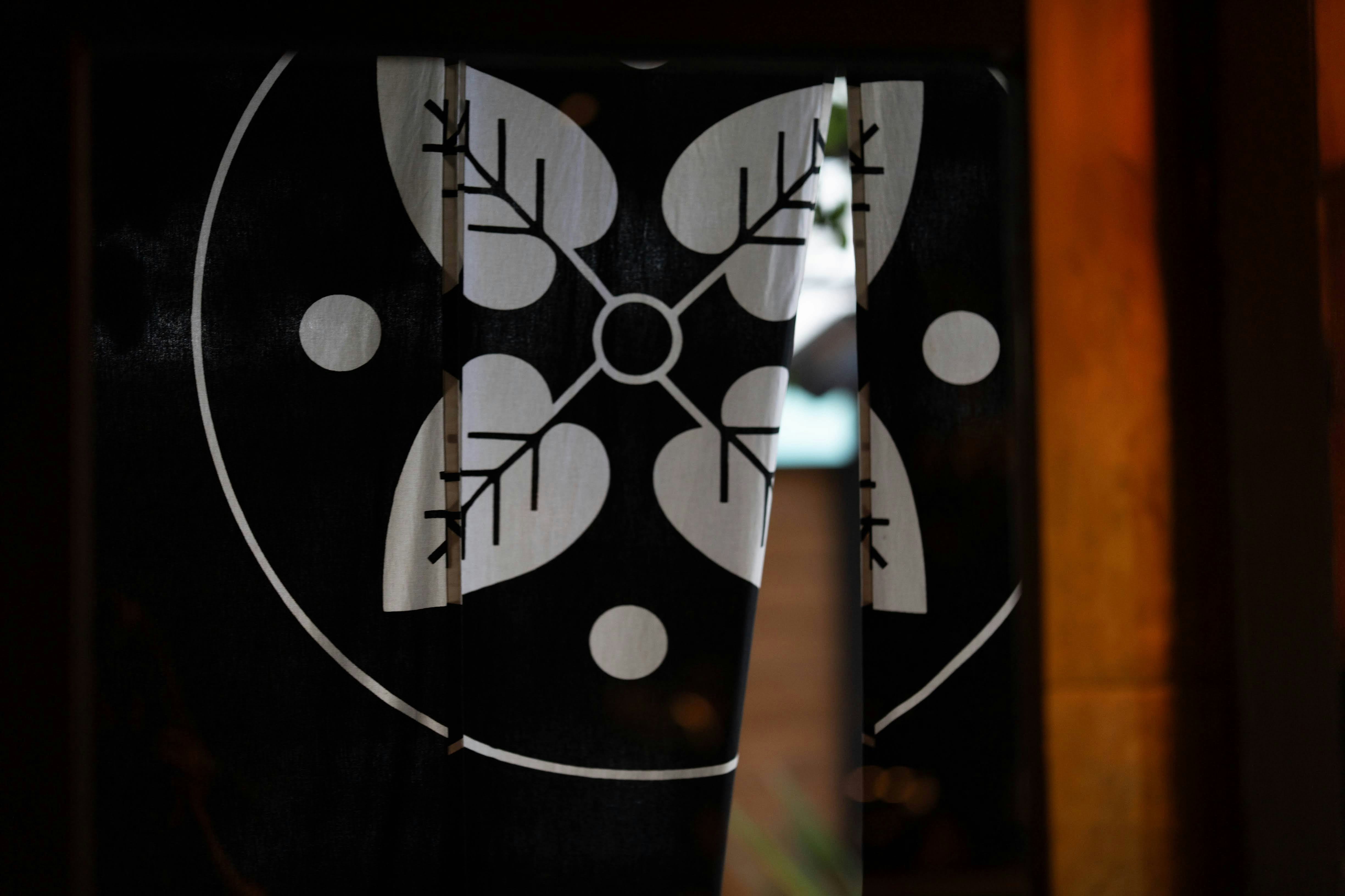 Black glass with white leaf pattern and circle pattern